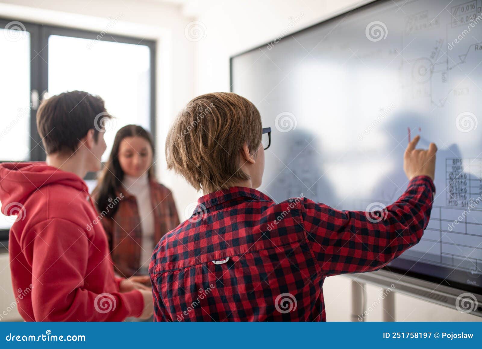 College Student Explaining Some Ideas on a Touch TV in Classroom. Stock ...