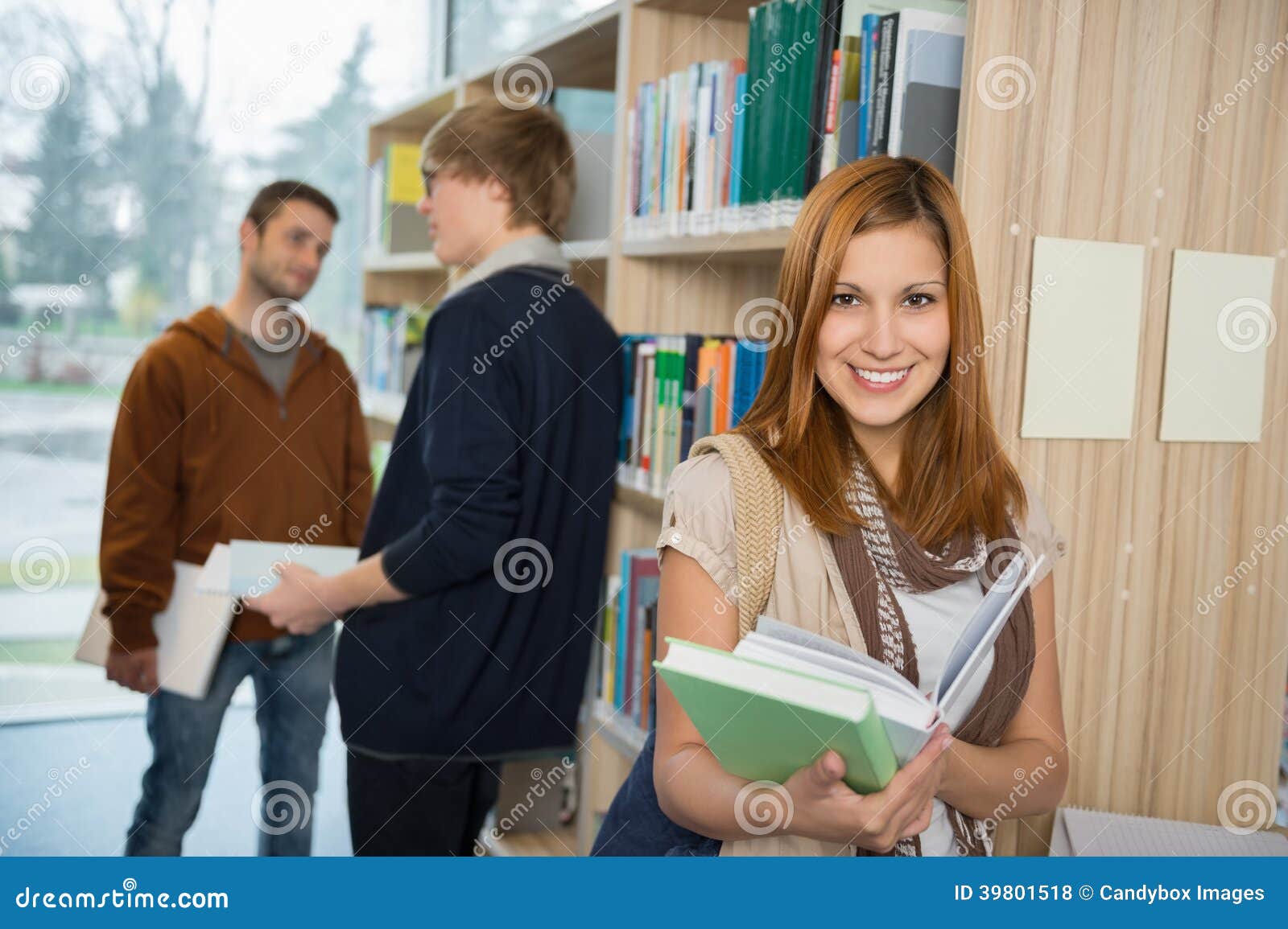 College Student Holding Books in Library Stock Photo - Image of friend ...