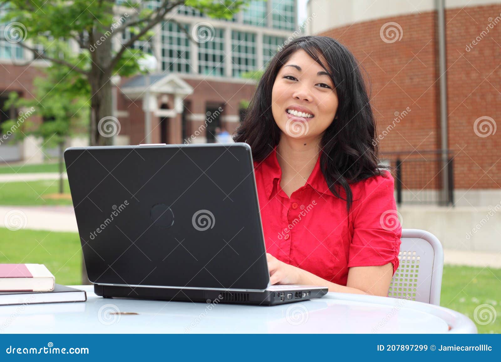 A Beautiful Asian College Student with Laptop on a University Campus ...
