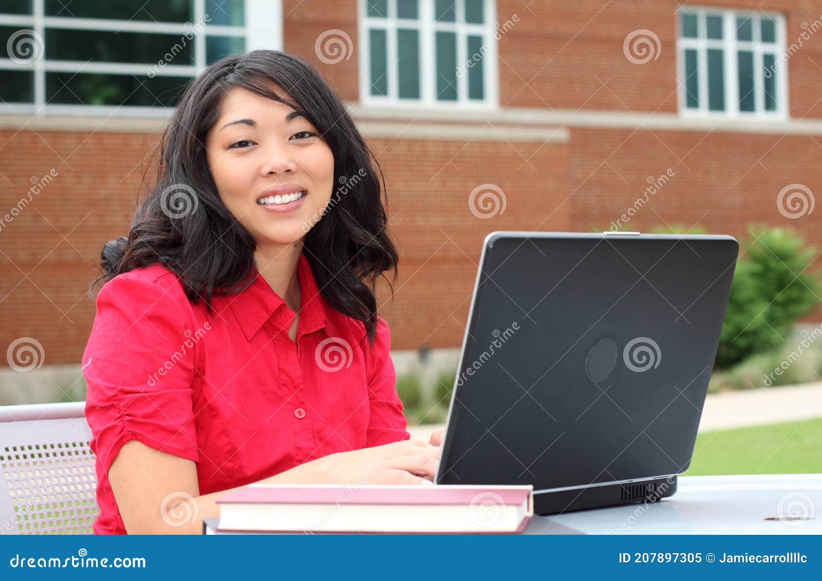 A Beautiful Asian College Student with Laptop on a University Campus ...