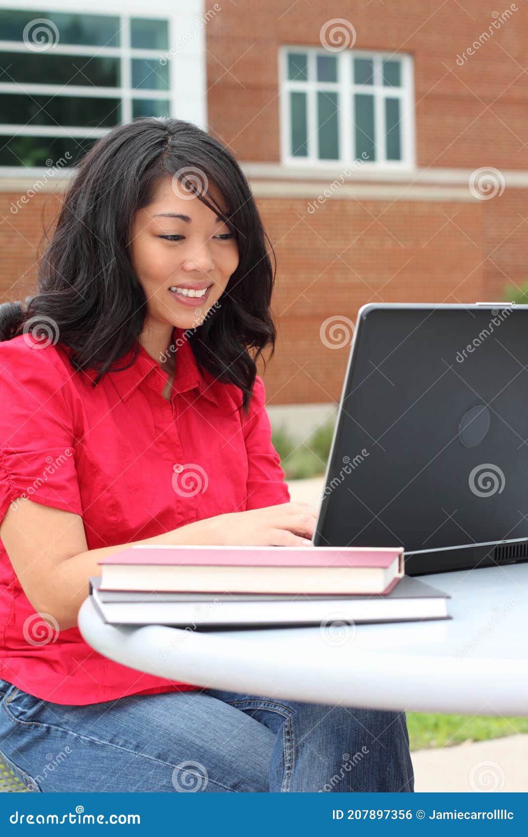 A Beautiful Asian College Student with Laptop on a University Campus ...