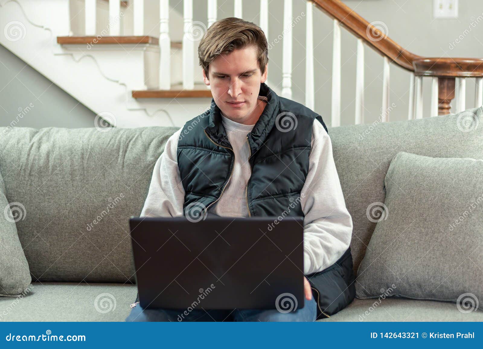 College Student Sitting on the Couch Using Laptop Stock Image - Image ...