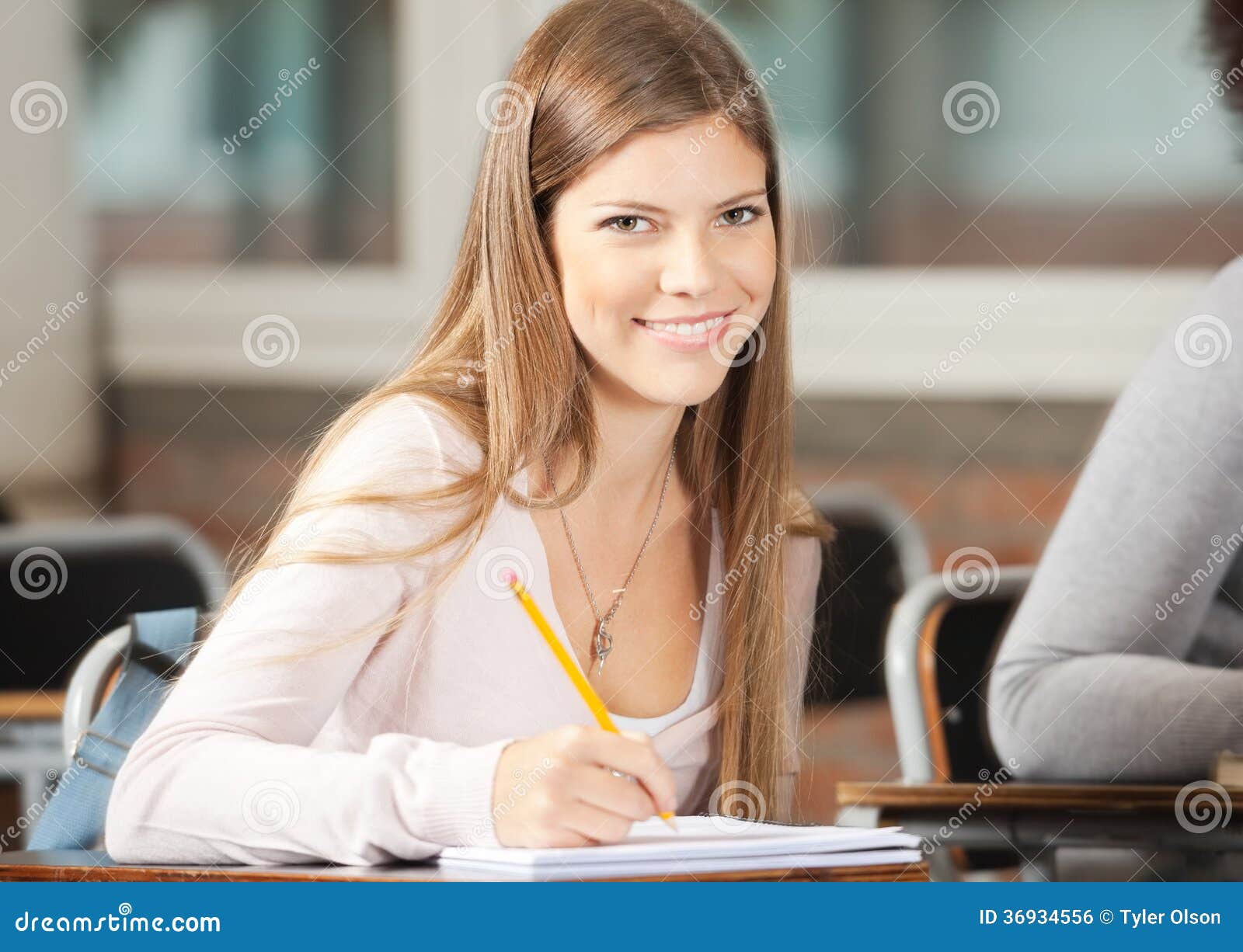 College Student Sitting at Desk in Classroom Stock Photo - Image of ...