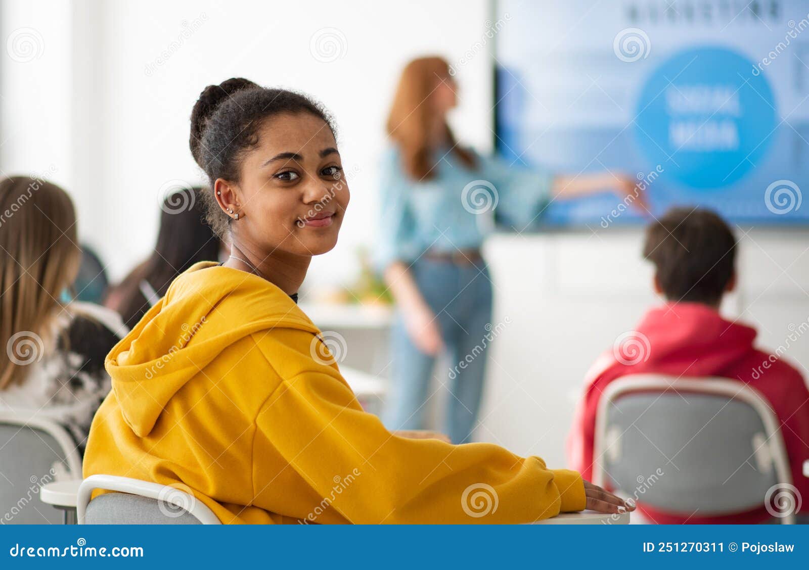 College Student Sitting in School-desk and Looking at Camera. Stock ...