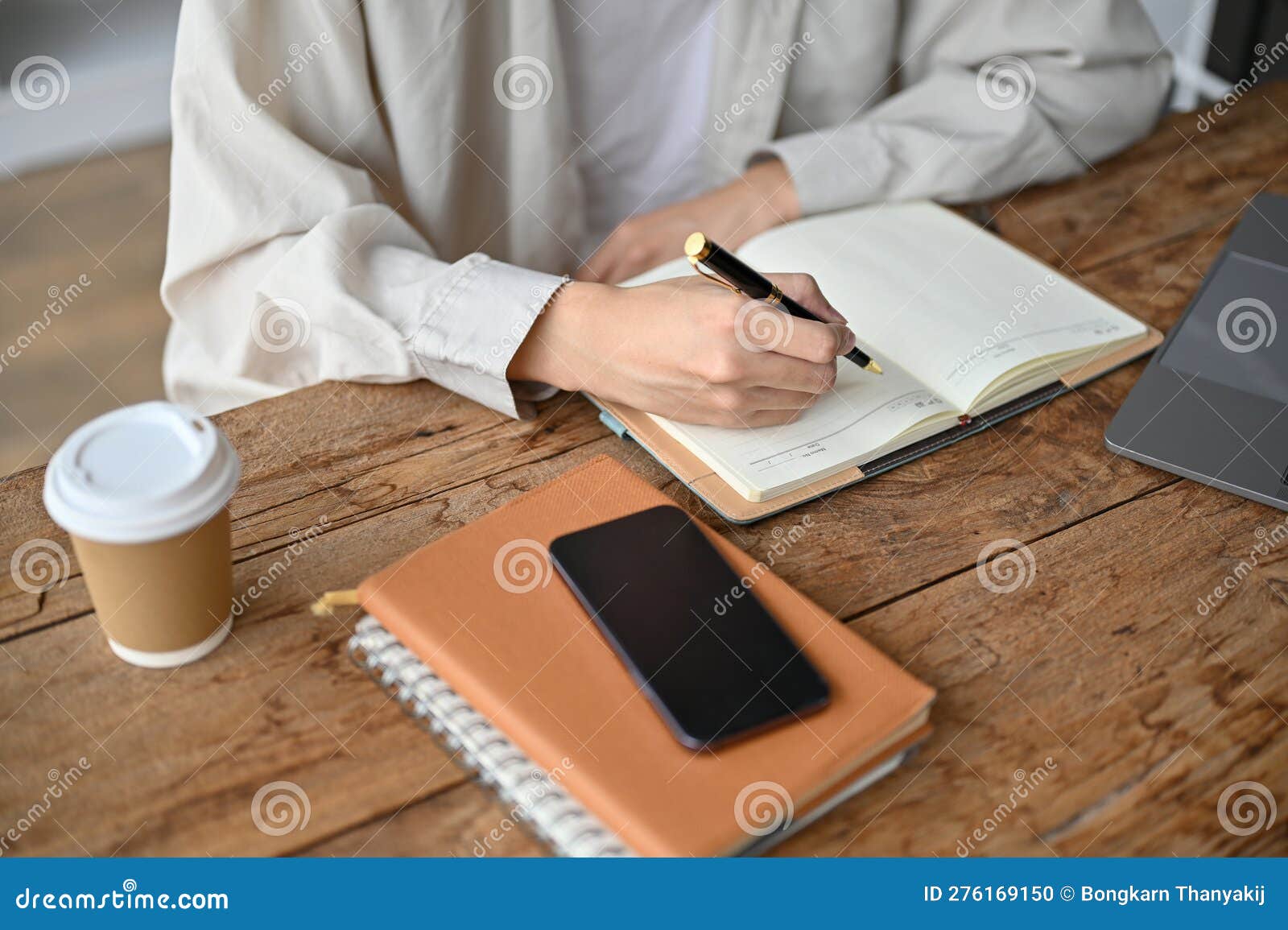 A College Student Taking a Note and Reading Textbook in the Study Room ...