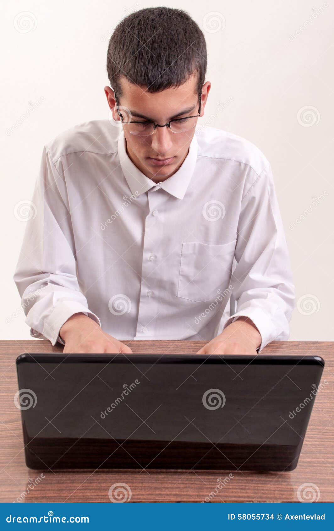 College Student Using His Laptop Computer in Classroom Stock Photo ...