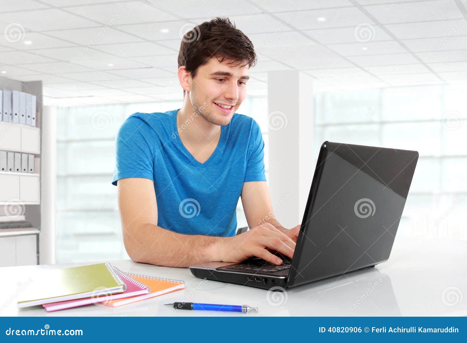 College Student Using His Laptop Stock Photo - Image of modern, male ...