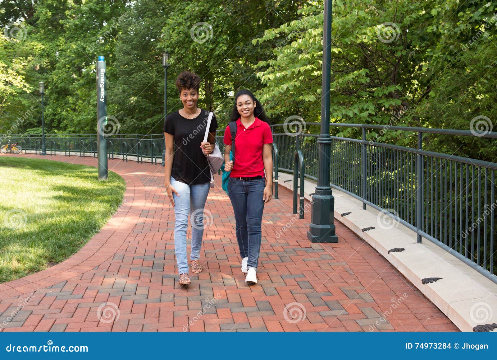 A College Student Walking on Campus Stock Photo - Image of chatting ...