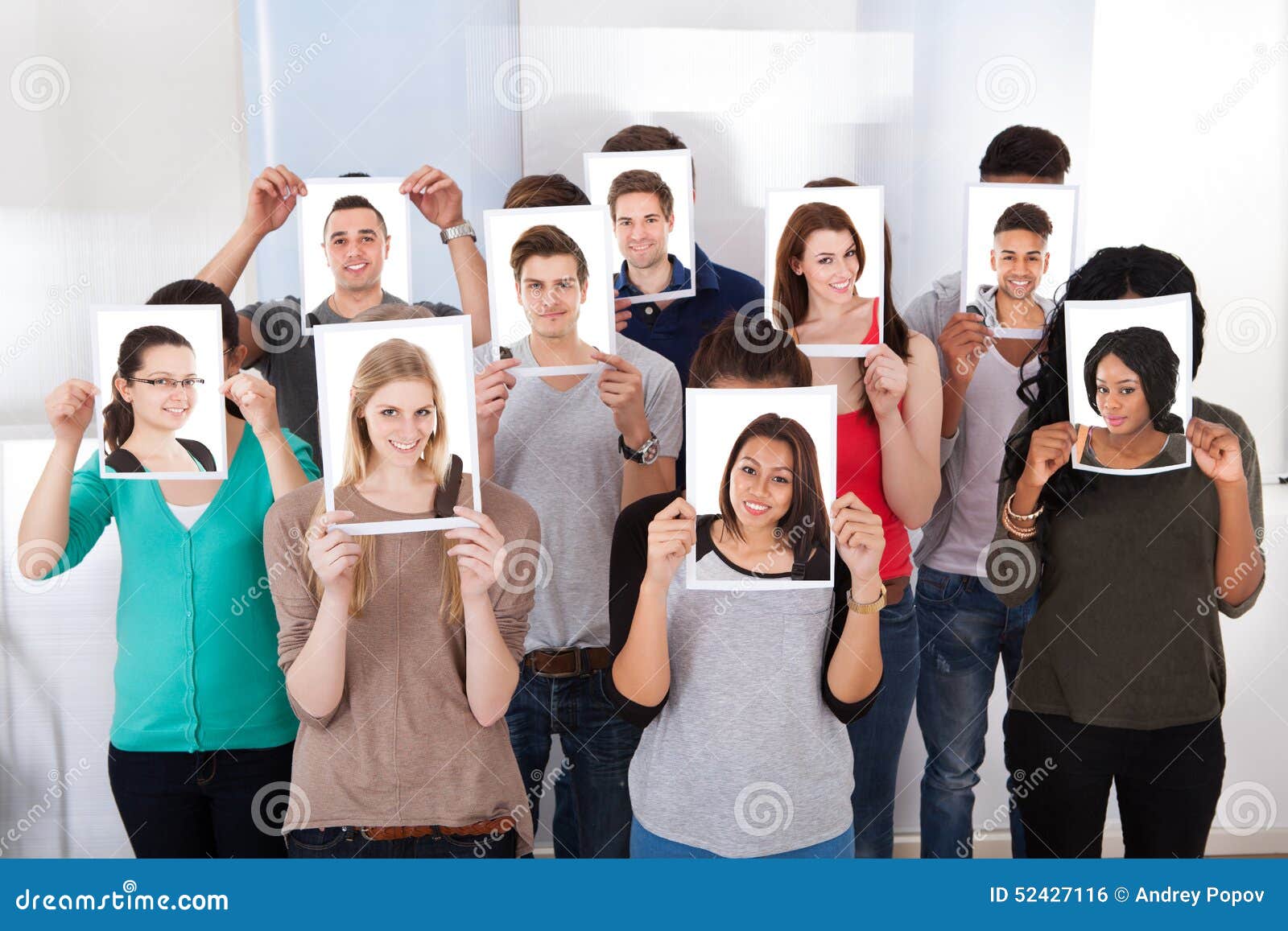 College Students Holding Photographs in Front of Faces Stock Photo ...
