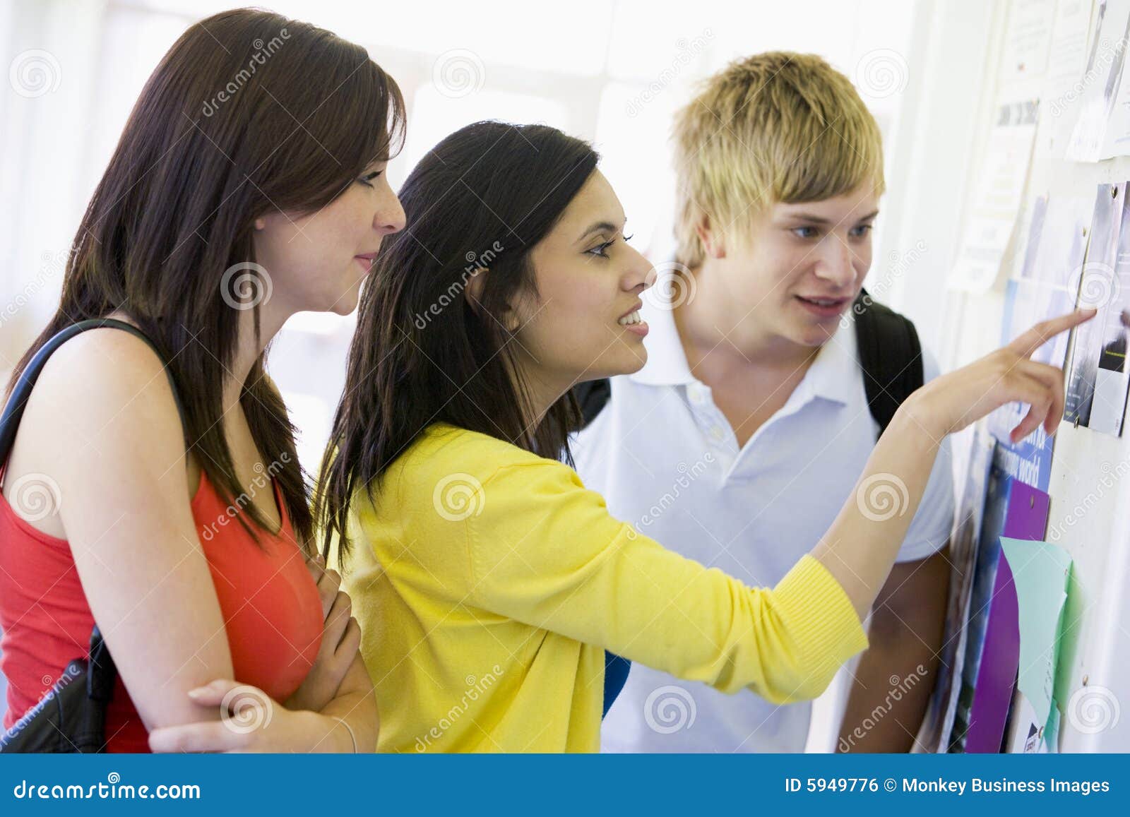 College Students Looking at a Bulletin Board Stock Photo - Image of ...