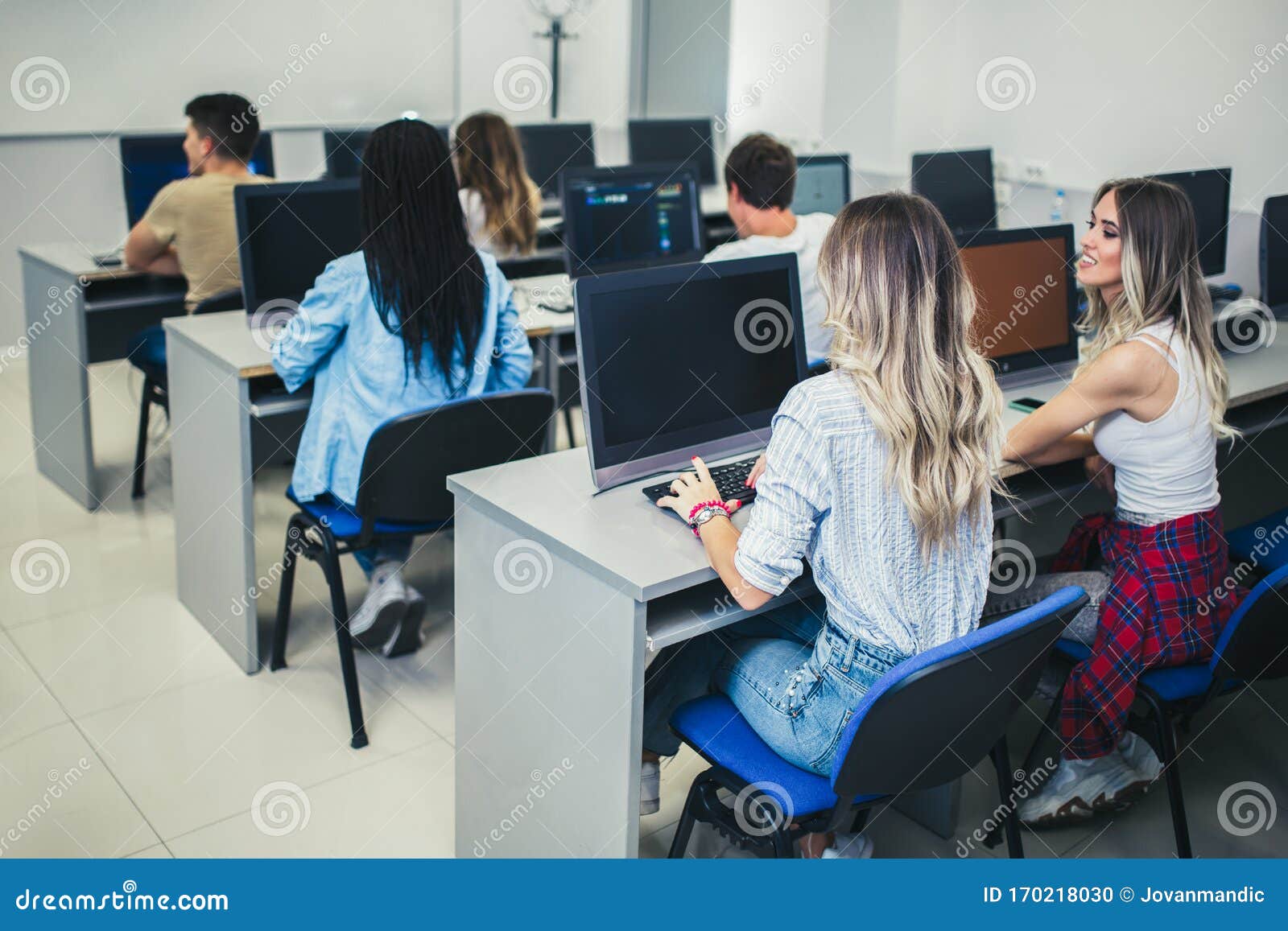 Students Sitting in a Classroom, Using Computers during Class Stock ...