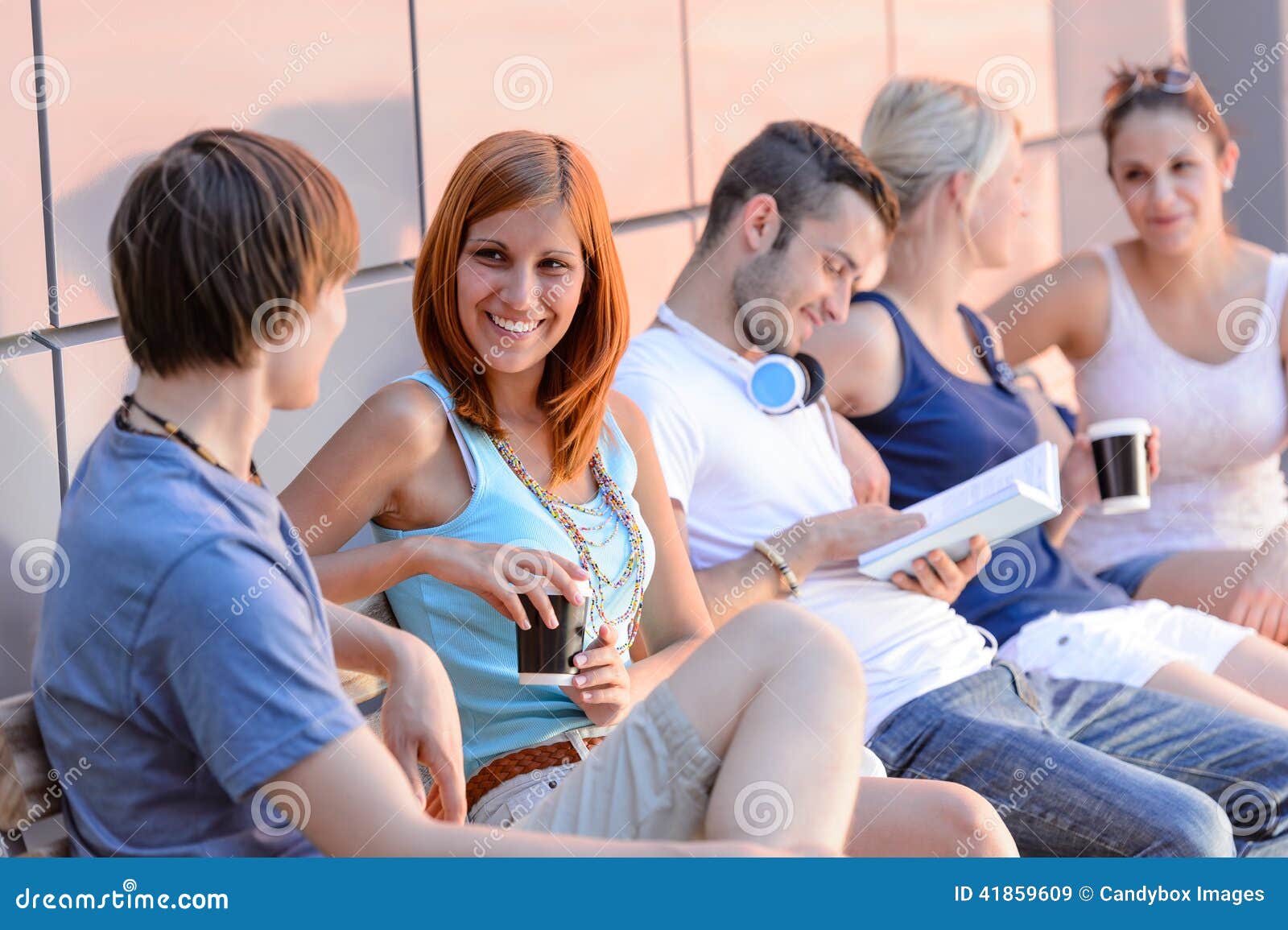 College Students Sitting by Modern Wall Outside Stock Image - Image of ...