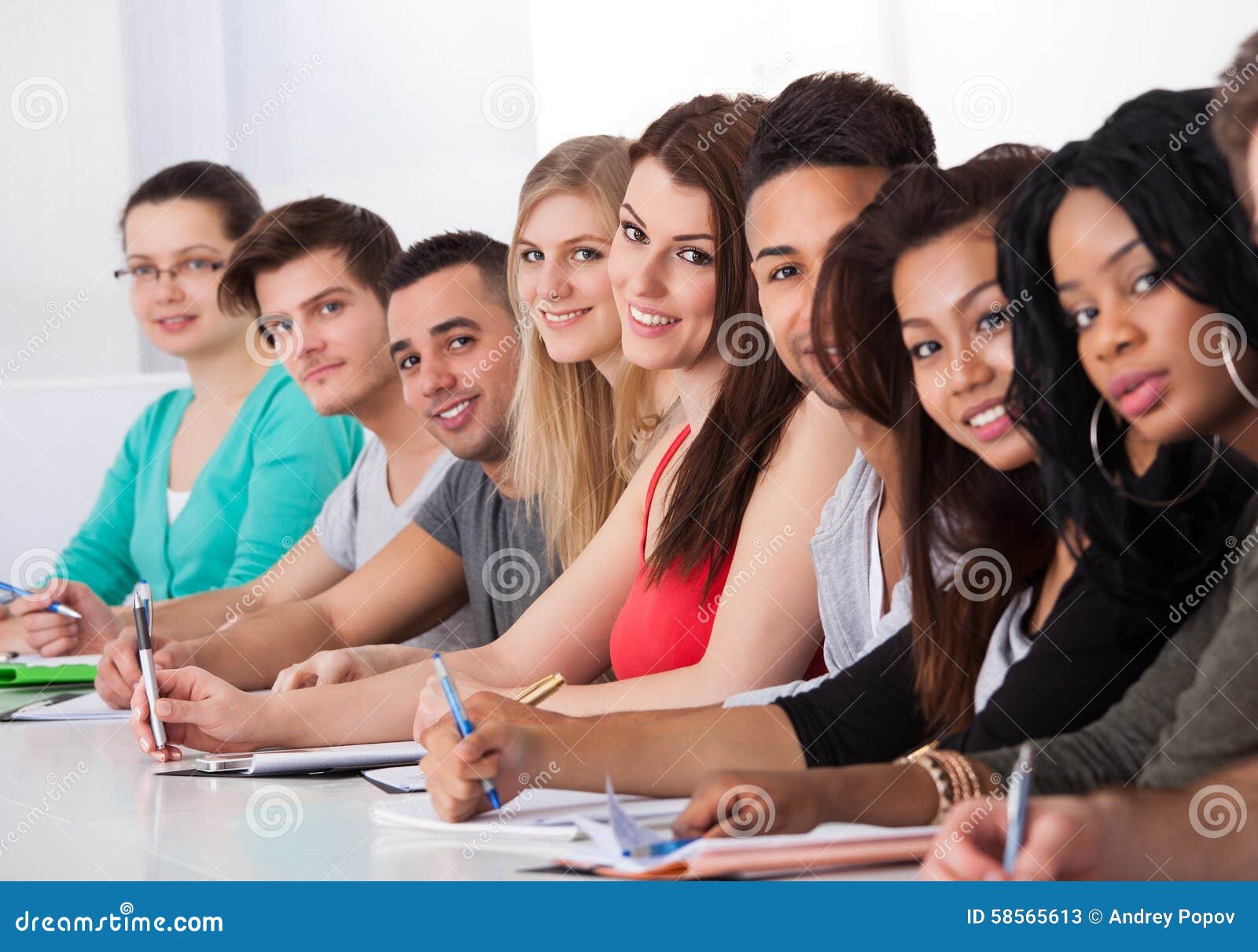 College Students Sitting in a Row at Desk Stock Image - Image of ...