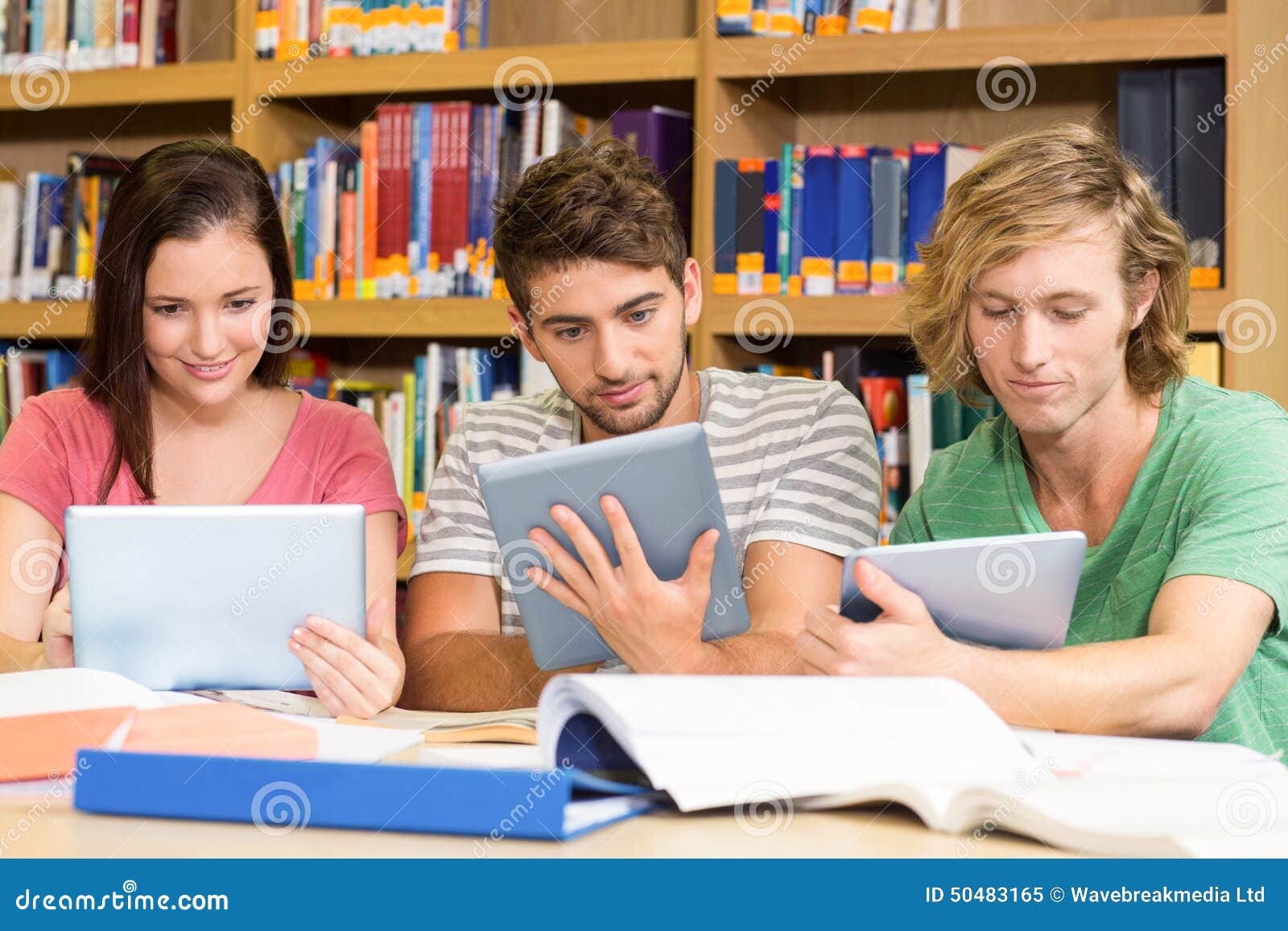 College Students Using Digital Tablets in Library Stock Image - Image ...
