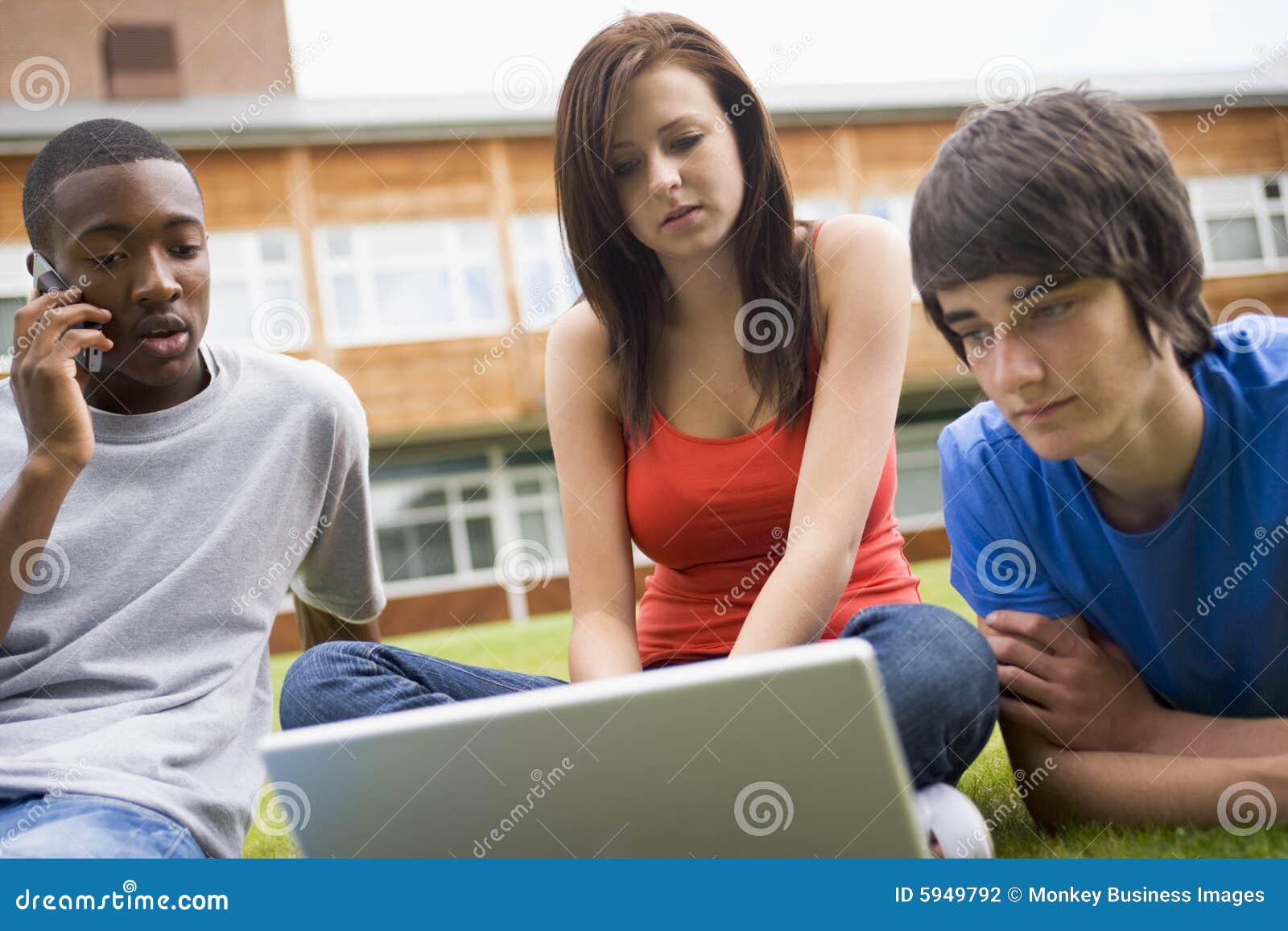 College Students Using Laptop on Campus Lawn Stock Photo - Image of ...