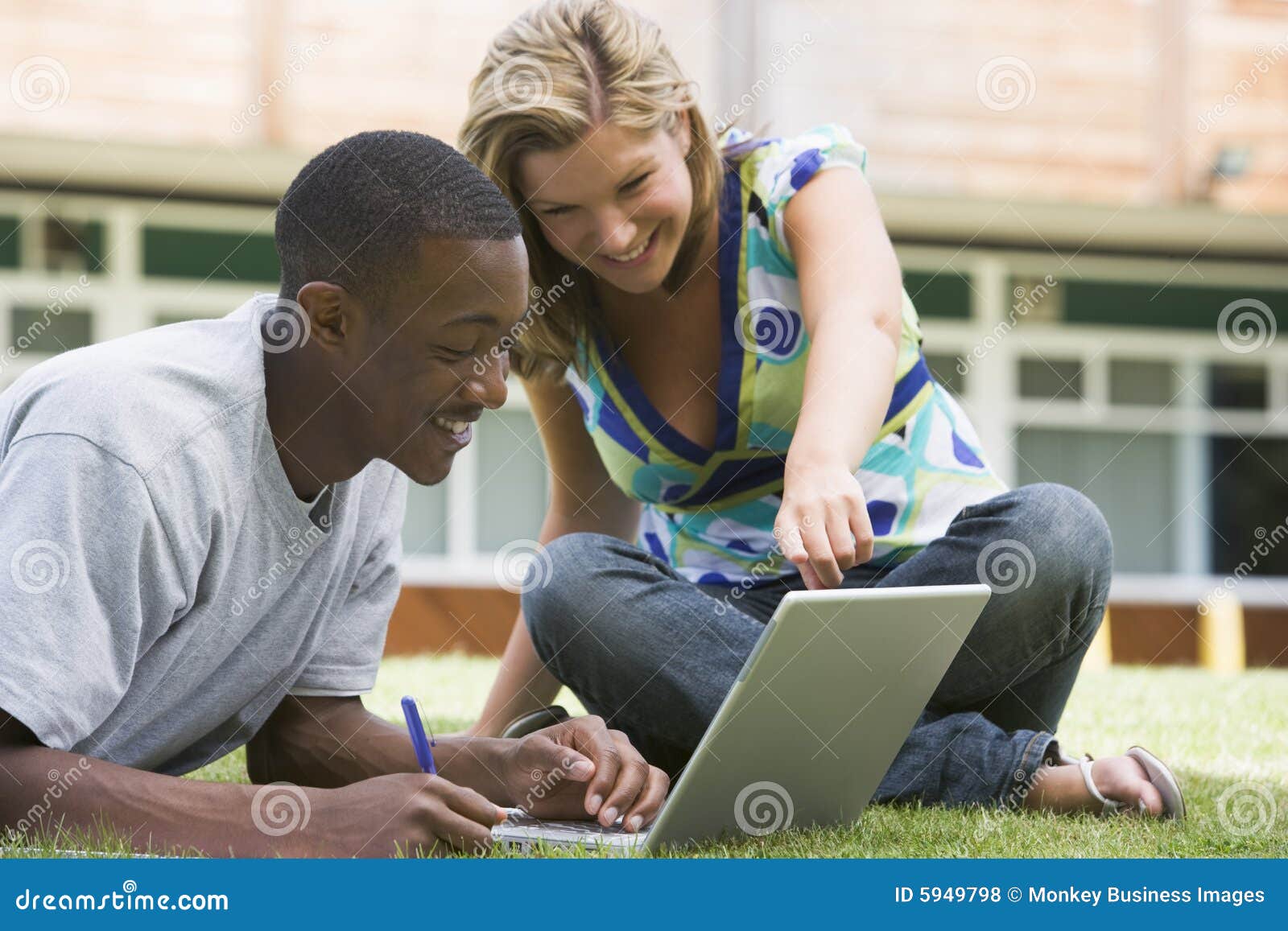 College Students Using Laptop on Campus Lawn Stock Photo - Image of ...
