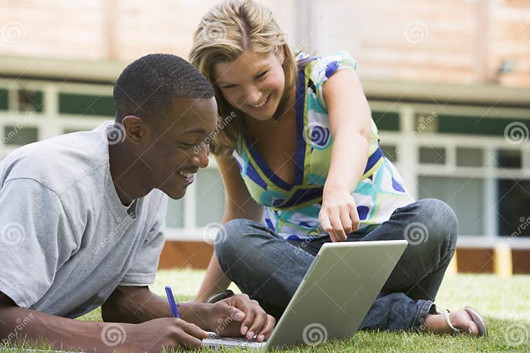 College Students Using Laptop on Campus Lawn Stock Photo - Image of ...