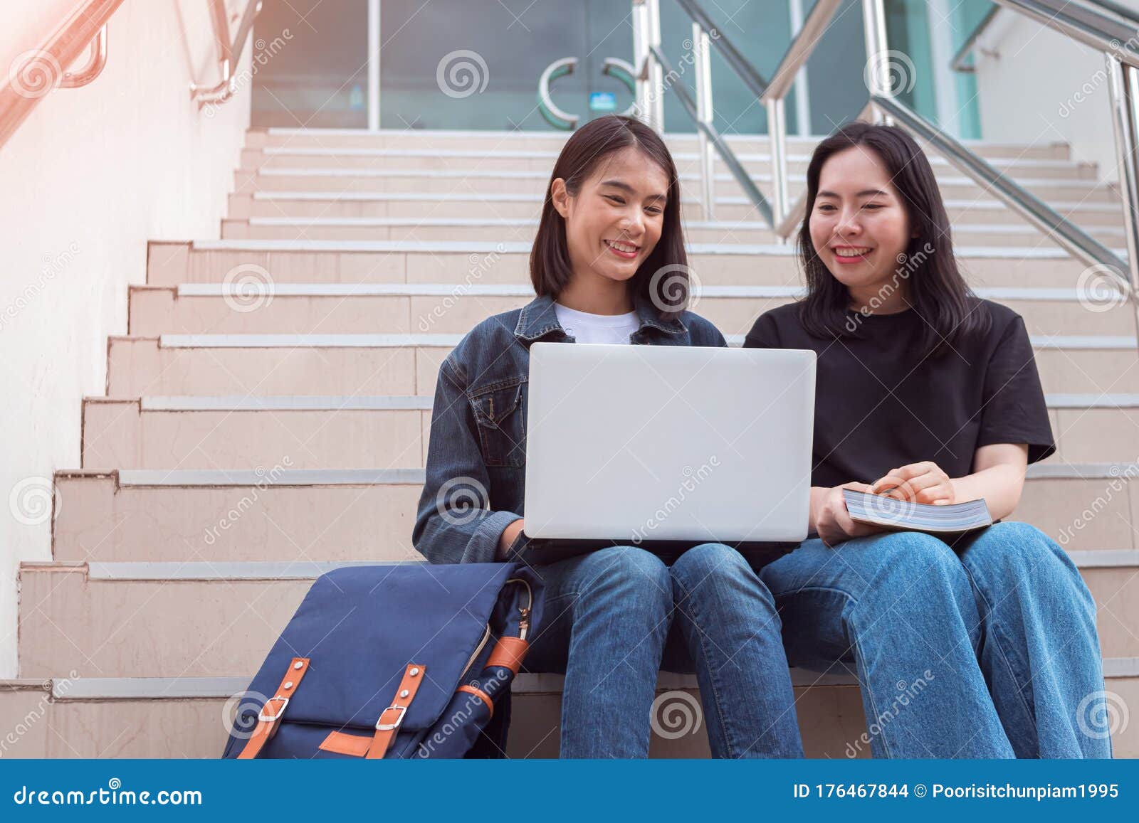 College Students is Using Laptop and Reading Book for Study Stock Photo ...