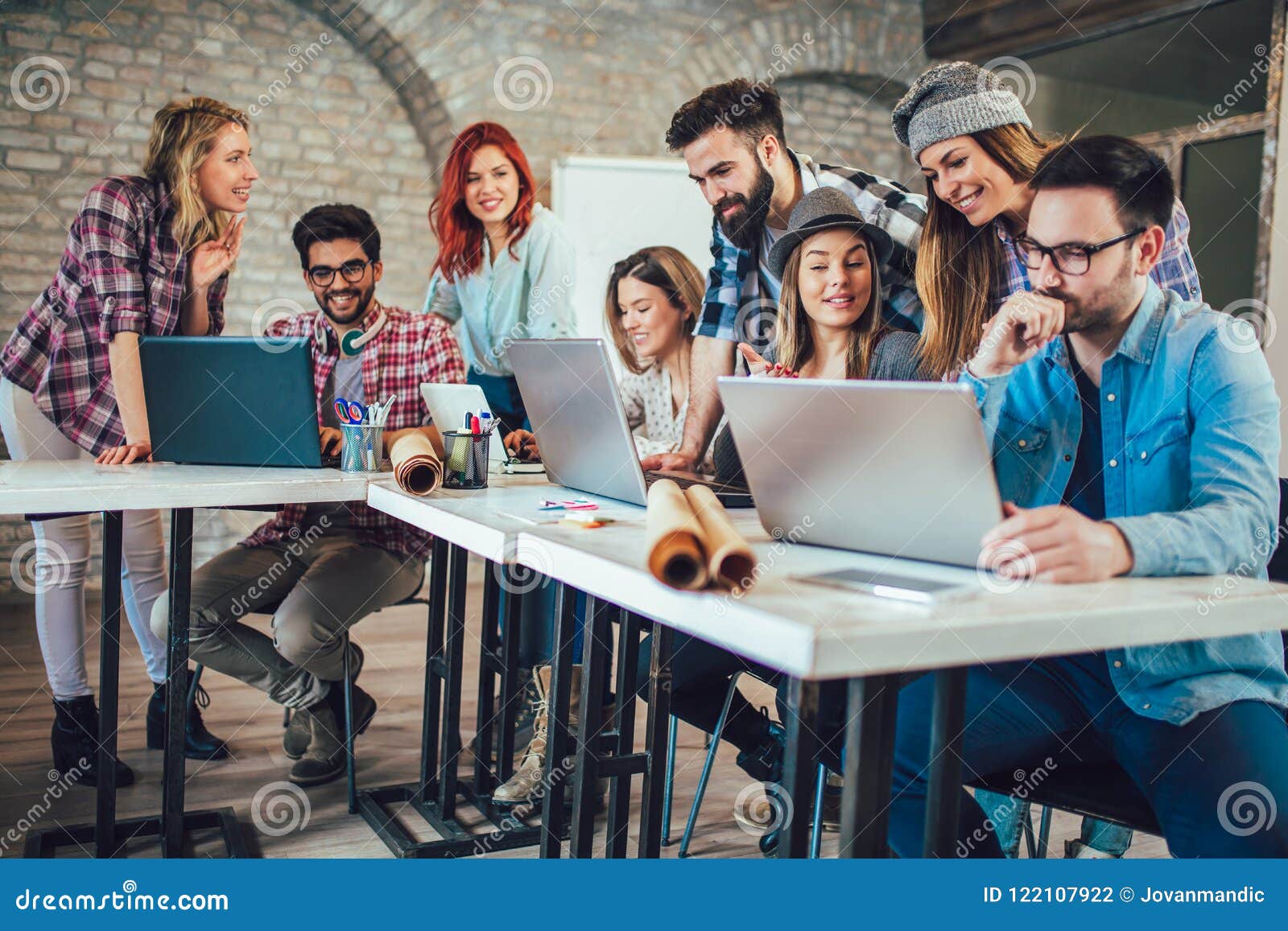 College Students Using Laptop while Sitting at Table. Stock Photo ...