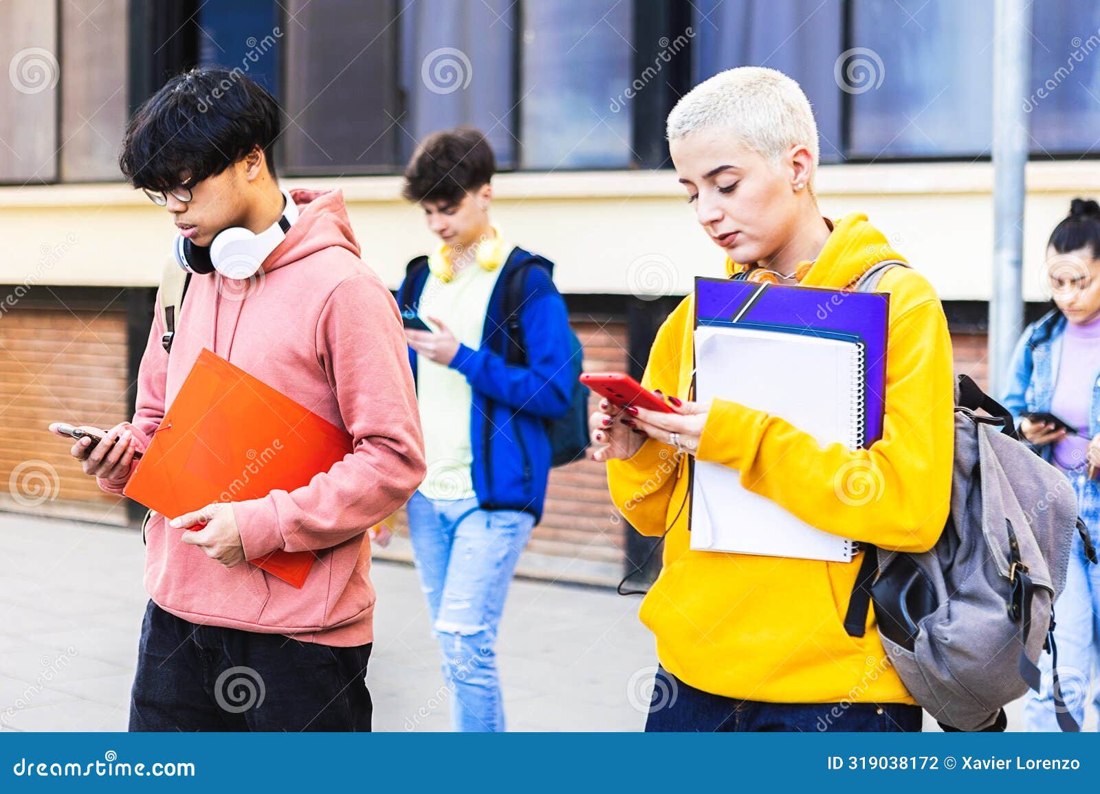 College Students Using Mobile Phone after Classes Outdoors. Stock Photo ...