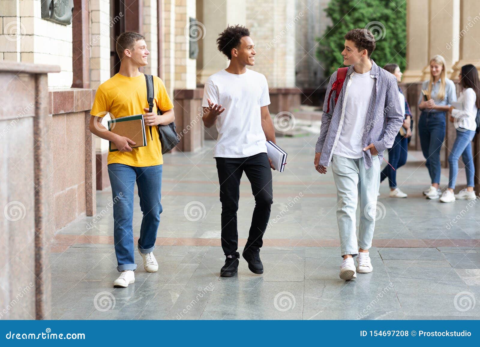 College Students Walking in Campus and Chatting Outdoors Stock Photo ...