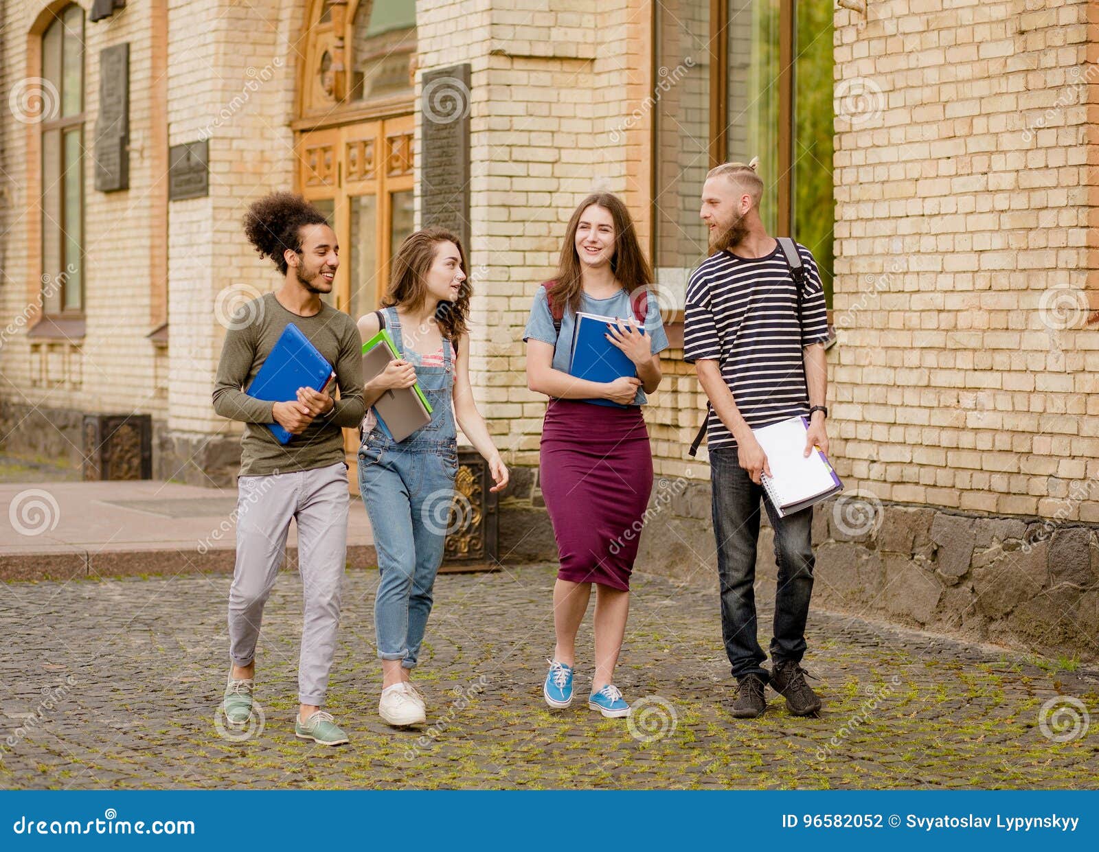 College Students Walking in Campus. Stock Photo - Image of notebook ...
