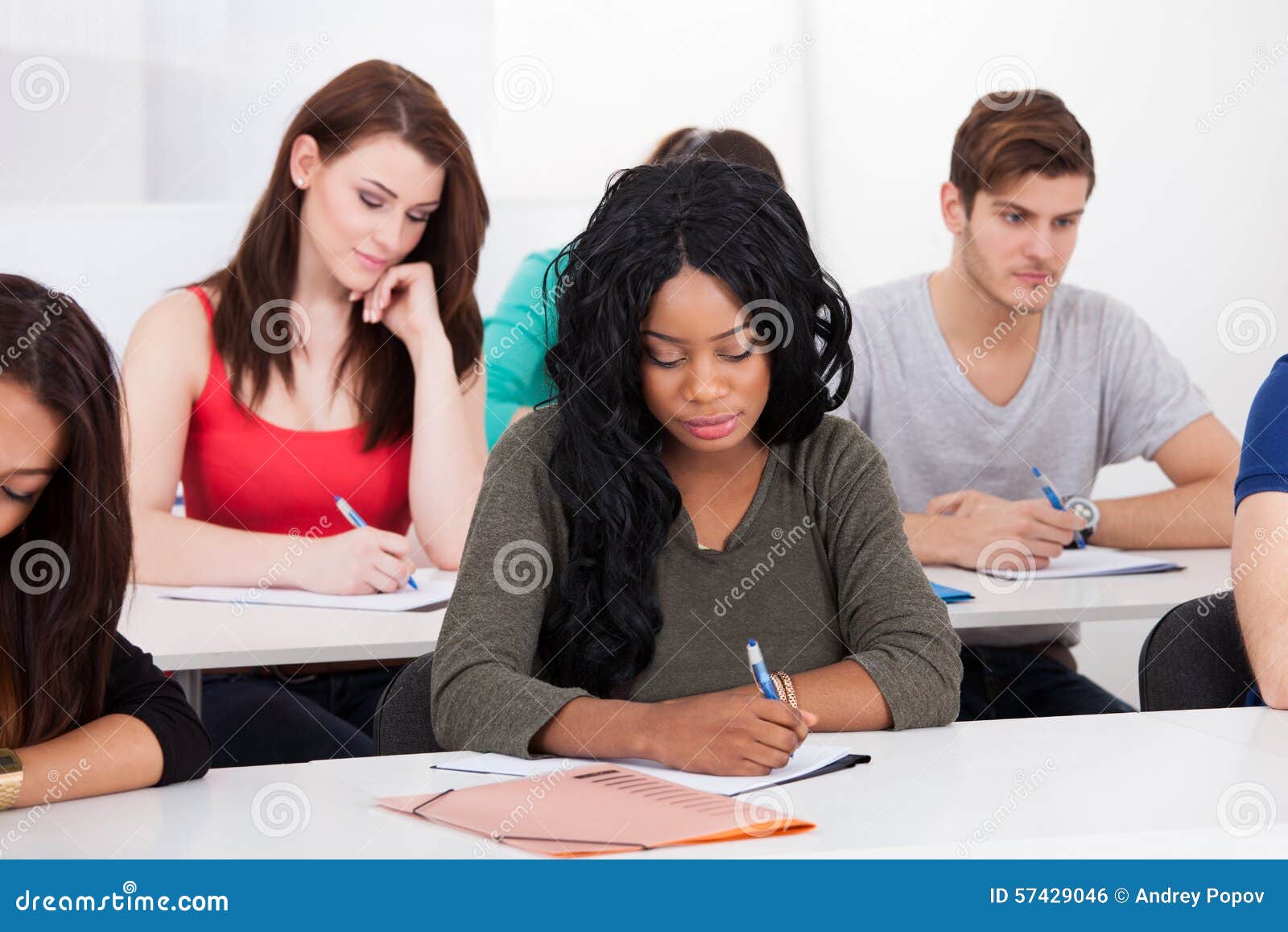 College Students Writing at Desk Stock Photo - Image of horizontal ...