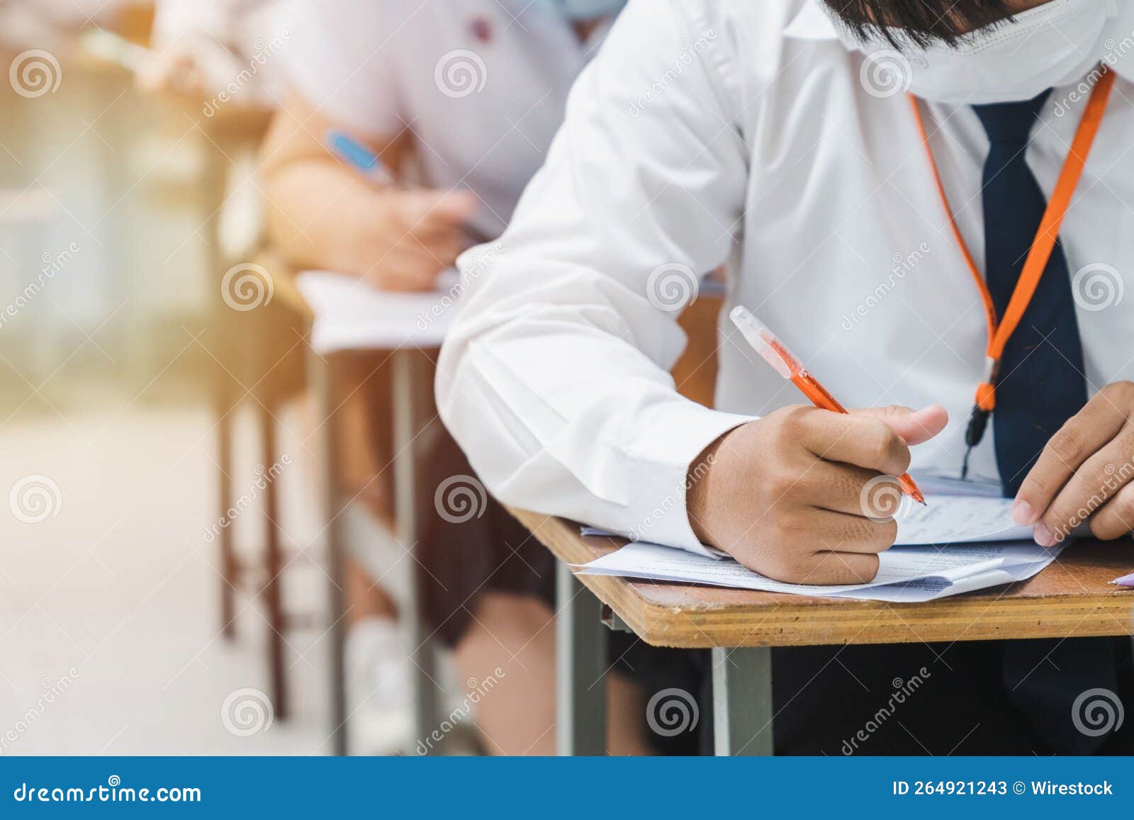 College Students Writing on Final Examination Papers in the Classroom ...