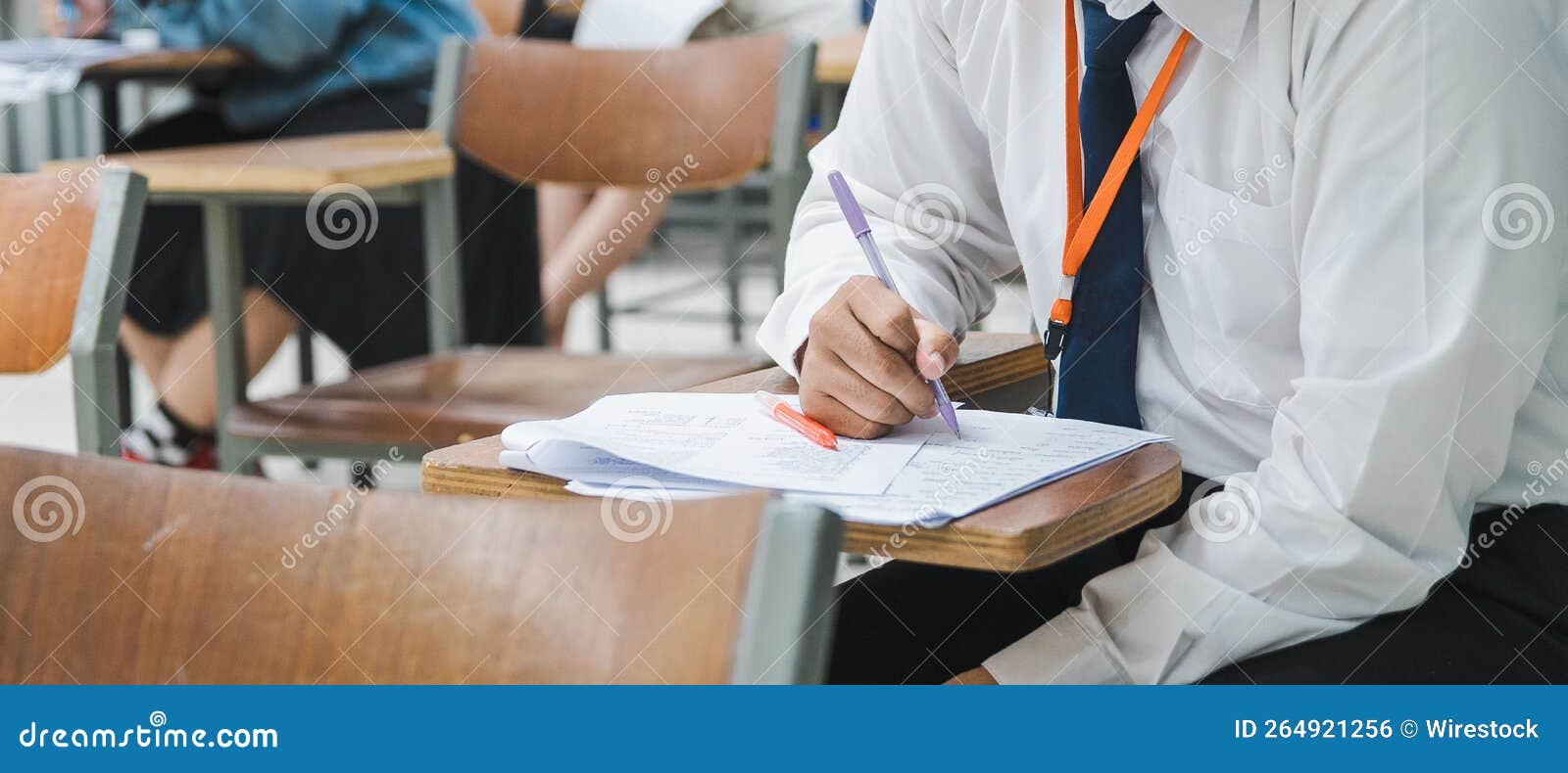 College Students Writing on Final Examination Papers in the Classroom ...