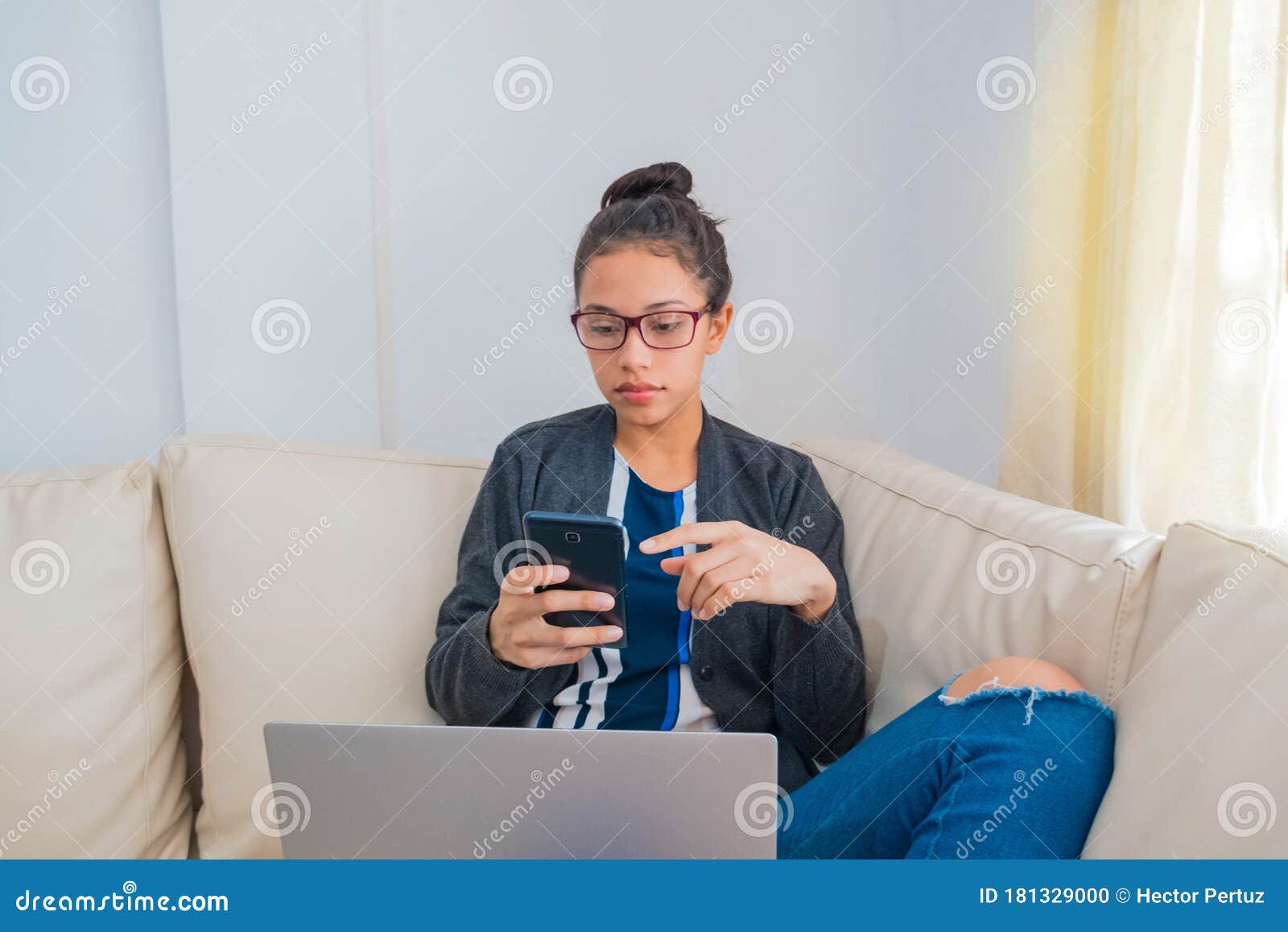 College Woman on the Couch Checking Her Cell Phone Stock Photo - Image ...