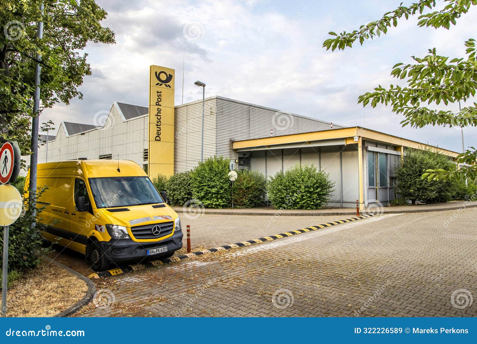 Cologne, Germany- July 21, 2023: Deutsche Post Office with Yellow Logo and Van Editorial Stock ...