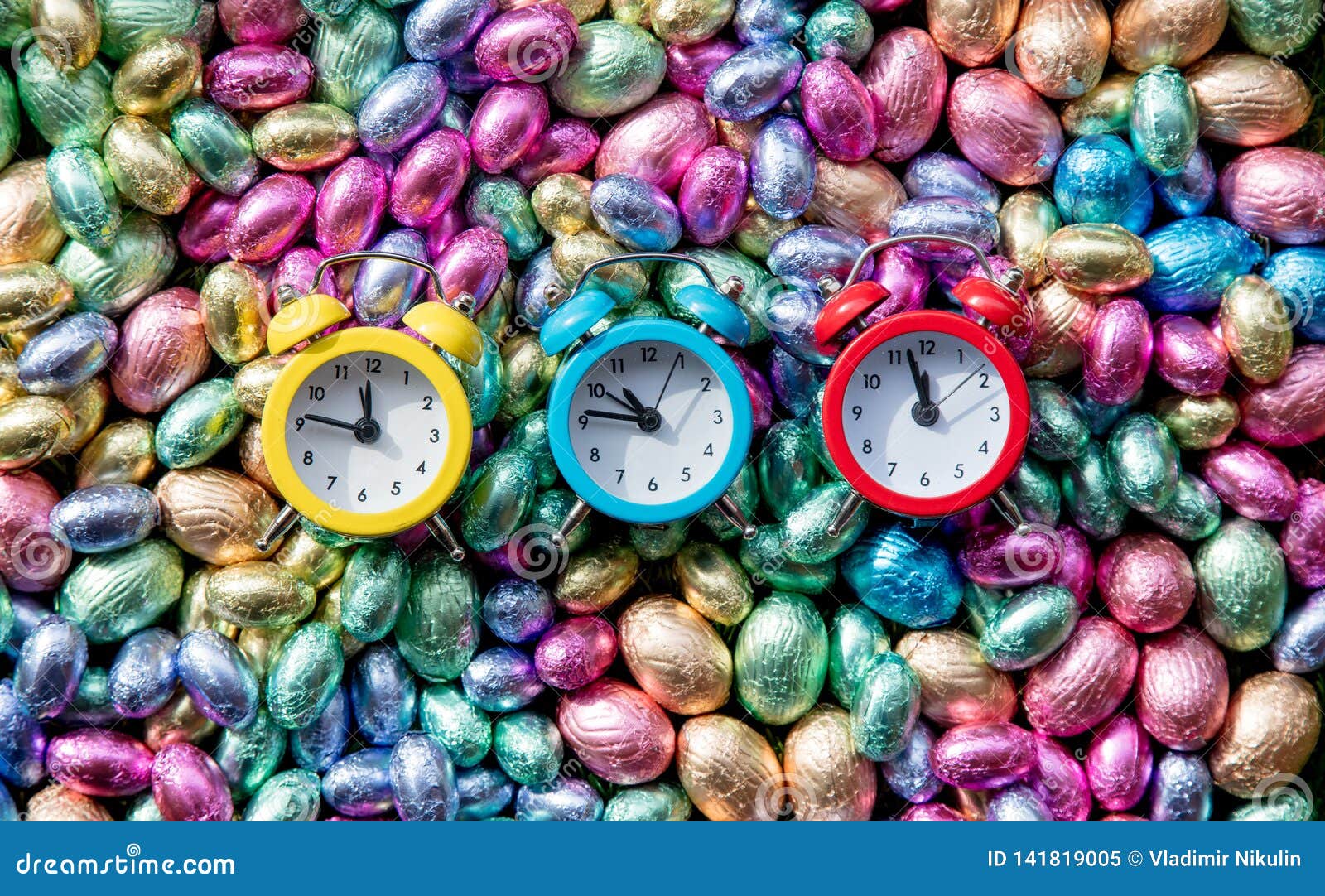 Color Chocolate Easter Eggs and Three Alarm Clocks Stock Image - Image ...