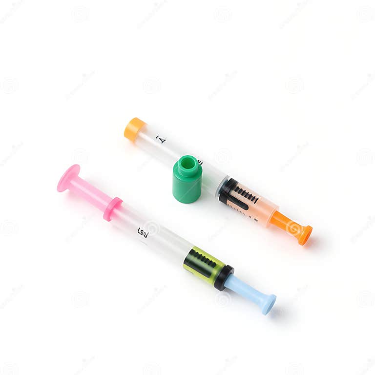 A Color Coded Set of Disposable Syringe Caps Placed on a White Backdrop ...