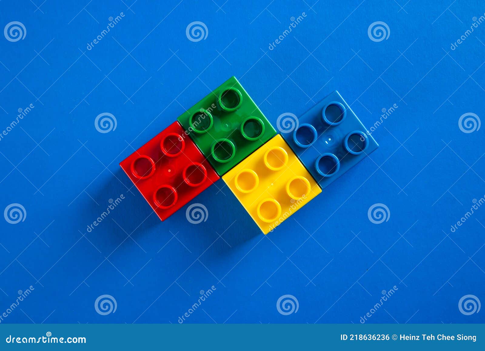 Color Plastic Building Blocks on Blue Background Stock Photo - Image of ...