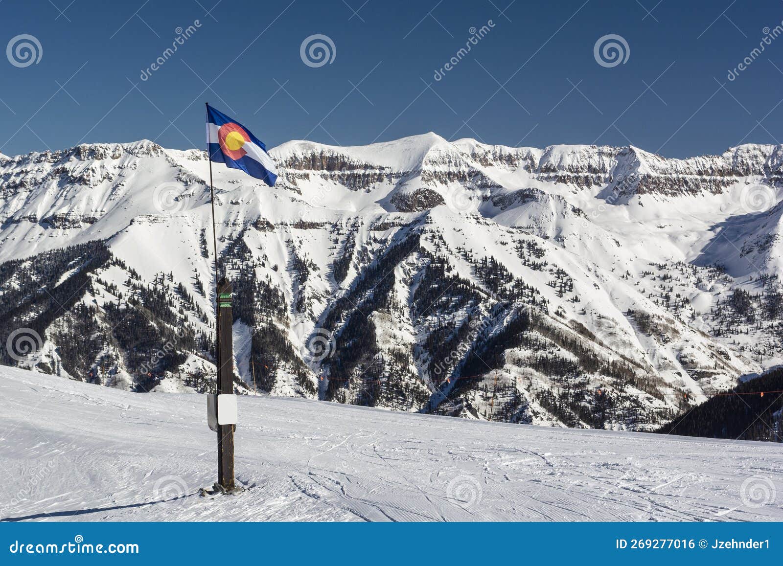 Colorado State Flag in the Rocky Mountains with Snow Stock Photo ...