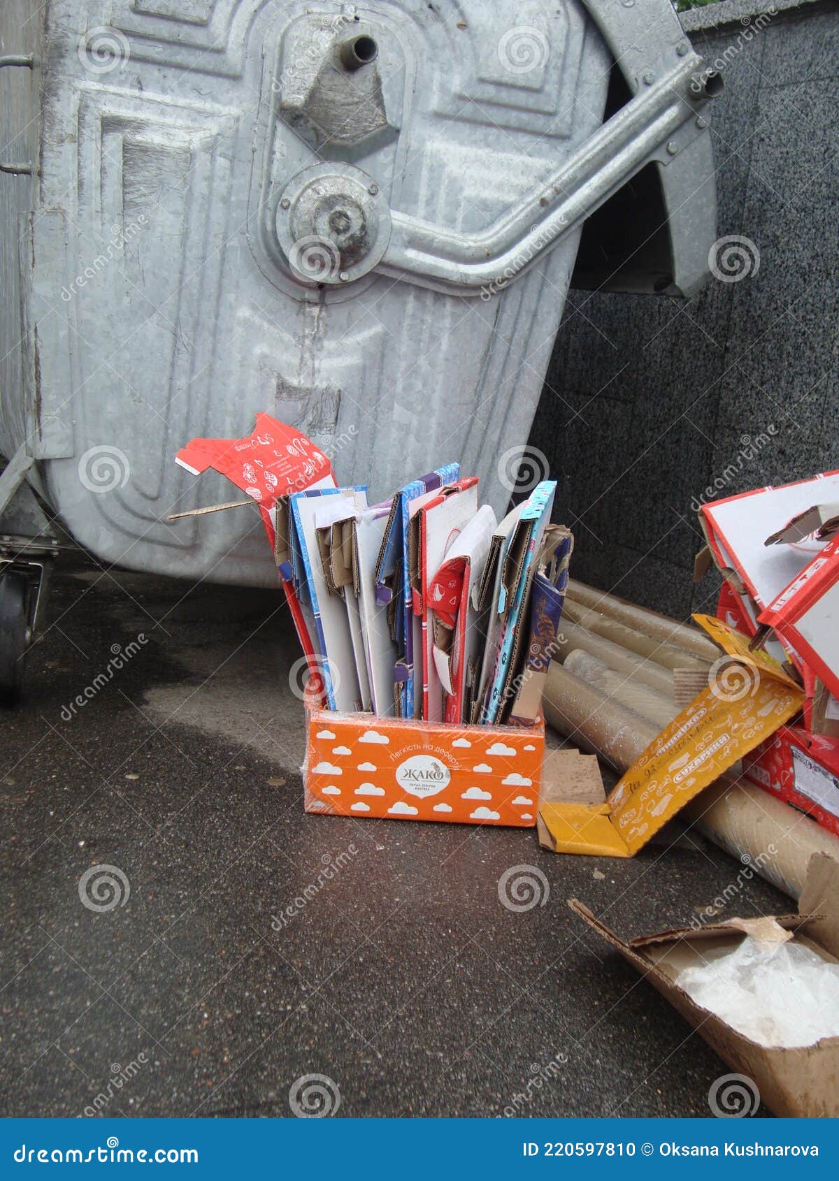 A Garbage Iron Container with Colored Boxes Alongside Stock Photo ...