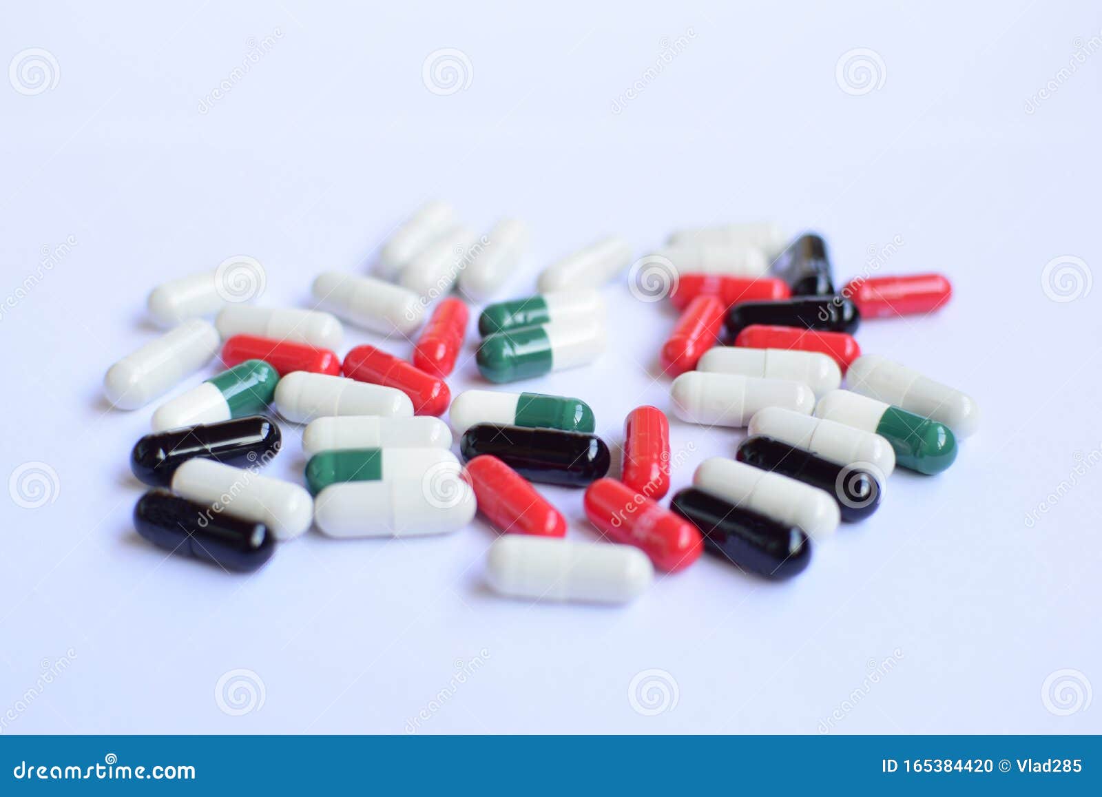 Colored Capsules Scattered on White Paper. Stock Photo - Image of ...