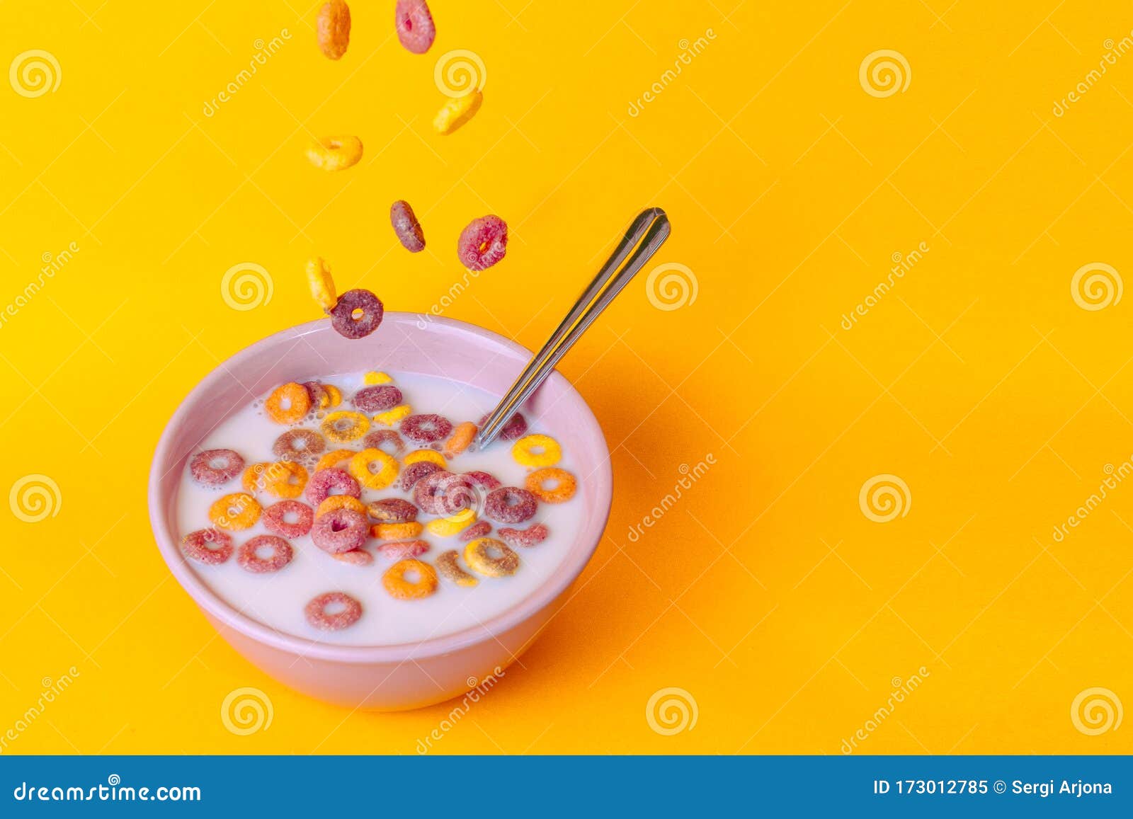 Colored Cereals Falling in a Pink Bowl with Milk and a Spoon Stock ...