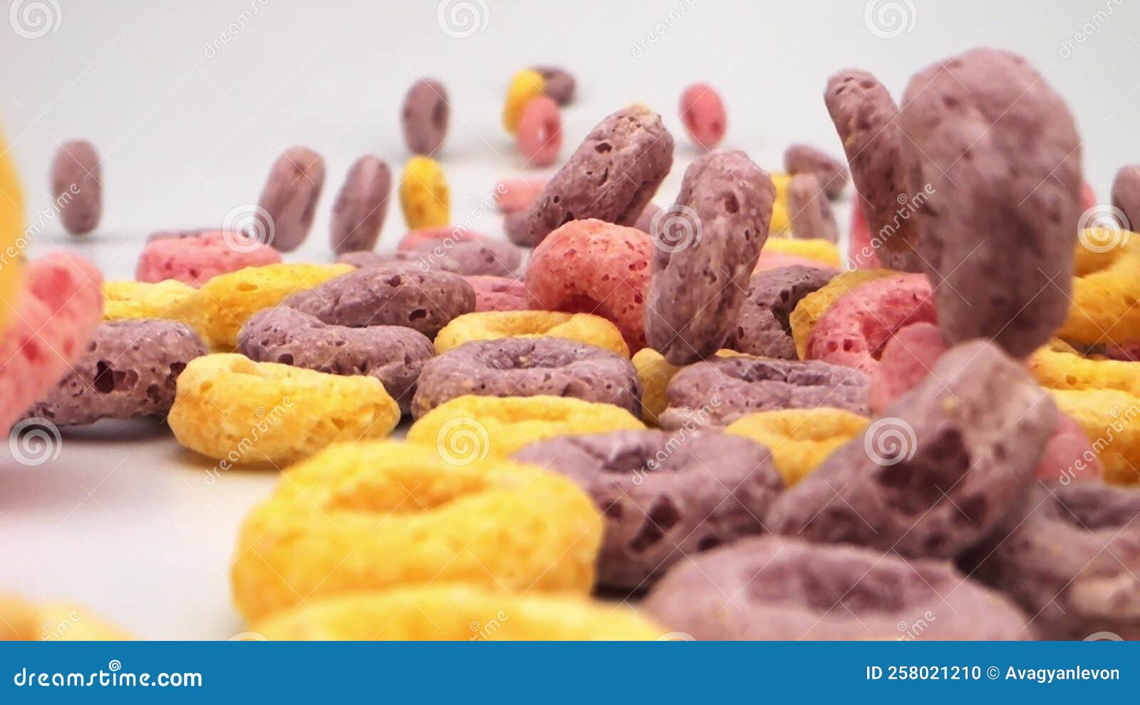 Multi-Colored Cornflakes Fall into White Background Slow Motion Stock ...