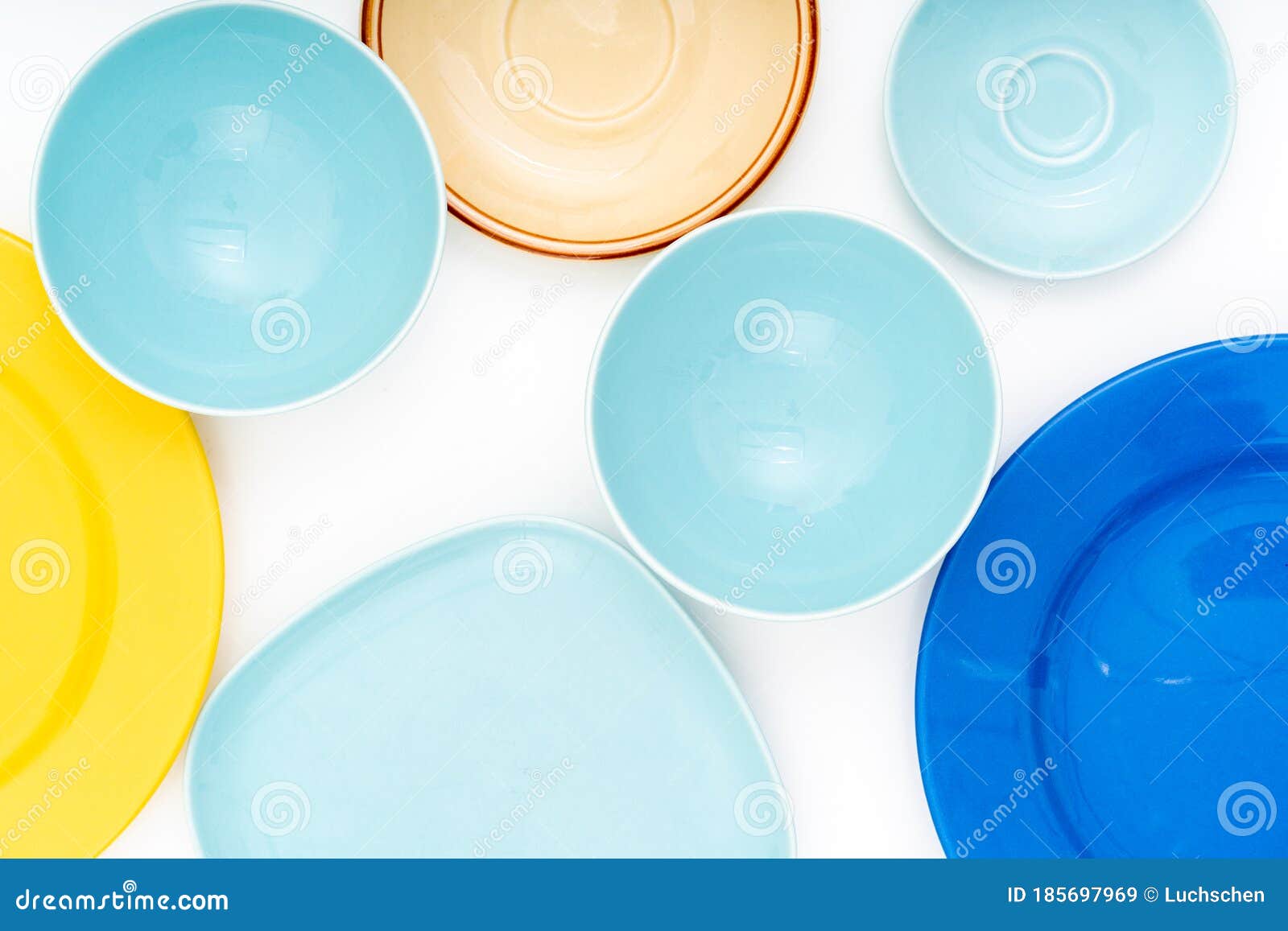 Colored Dinnerware Plates on White Table Stock Image - Image of ...