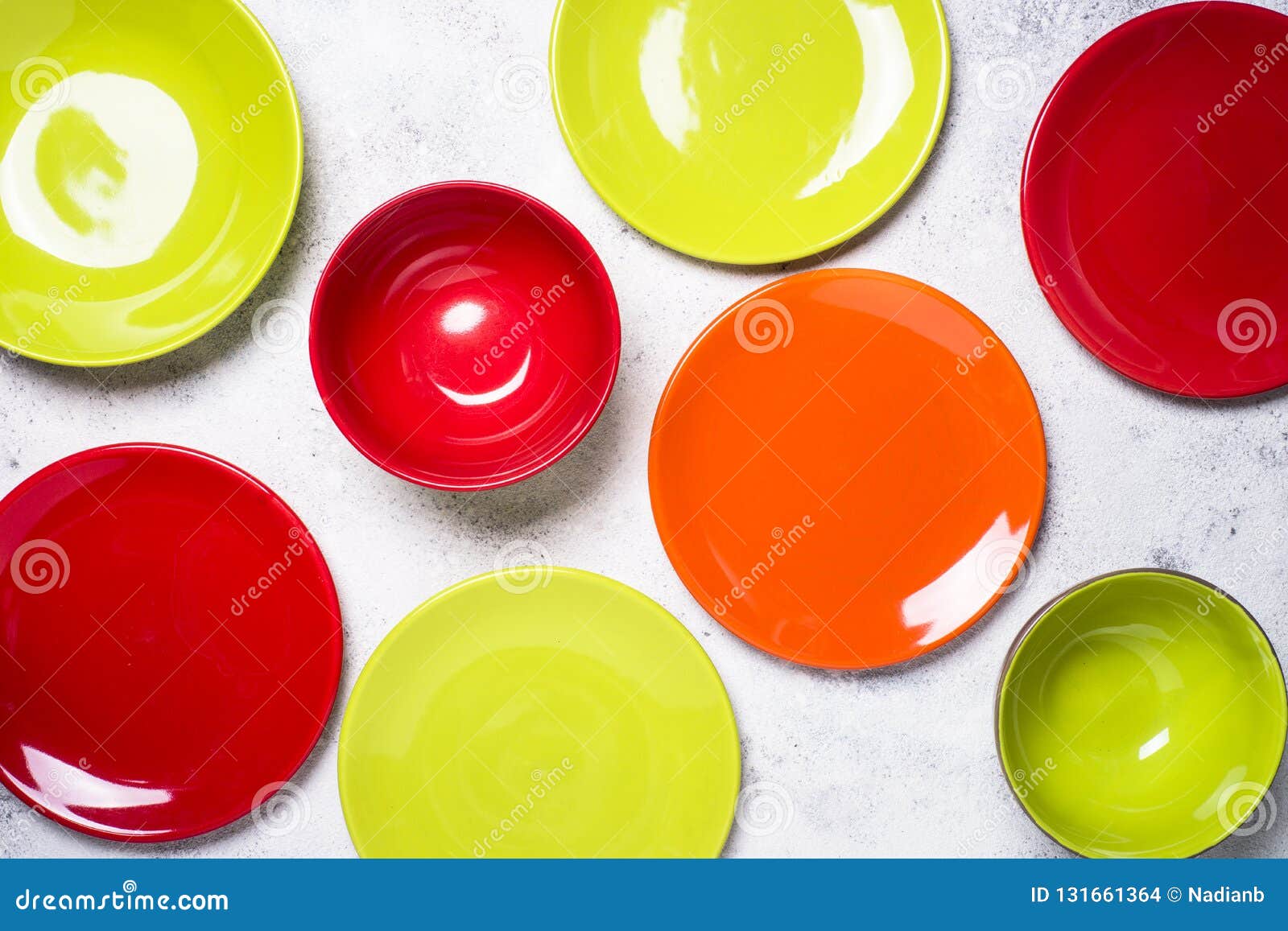 Colored Dinnerware - Red and Green Plates on Light Stone Table. Stock ...