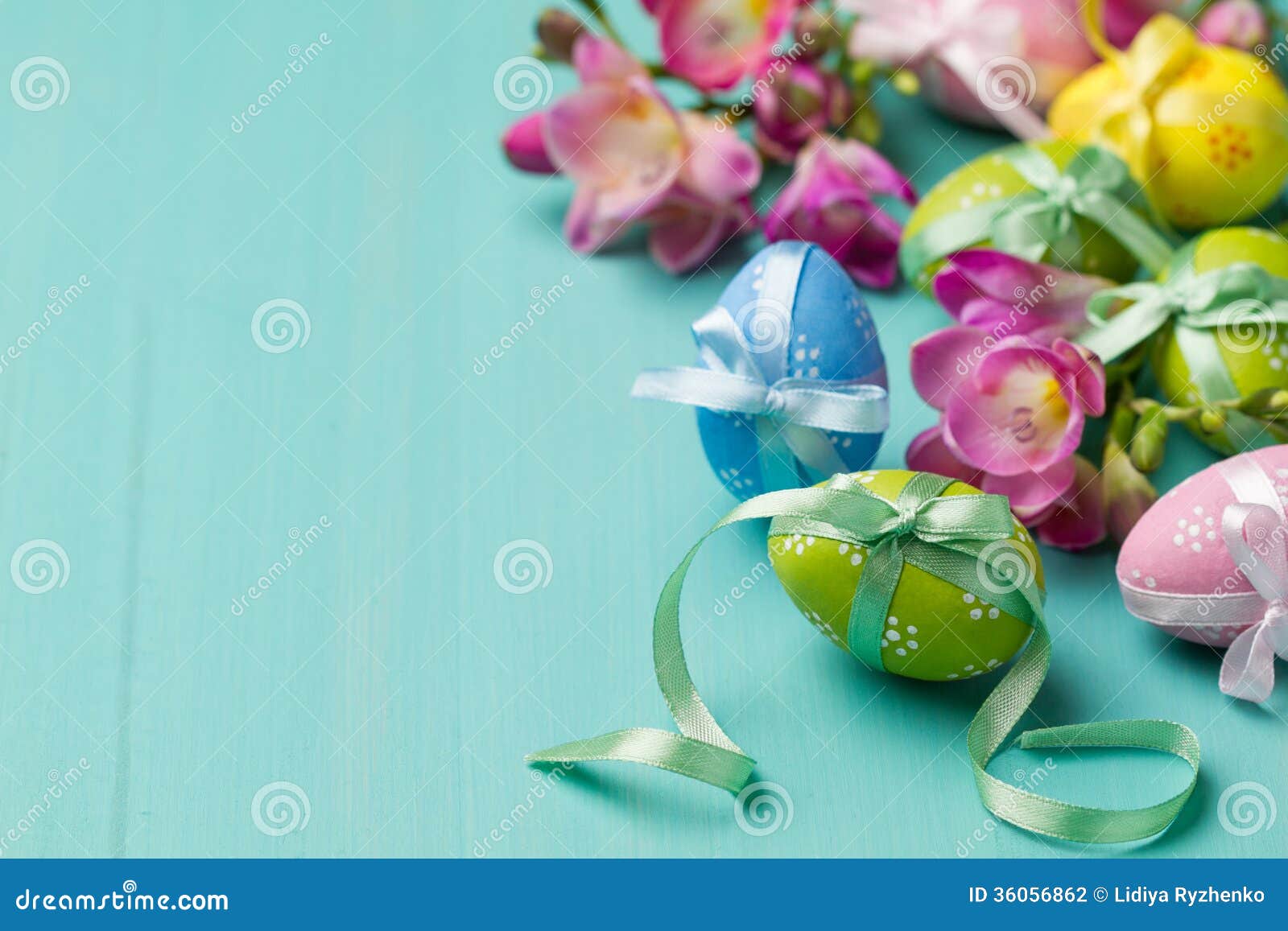 Colored Easter Eggs and Flowers on a Turquoise Table Stock Photo ...
