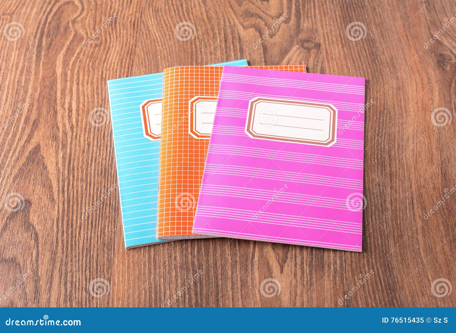 Colored Exercise Books on the Blue Wooden Background Stock Image ...