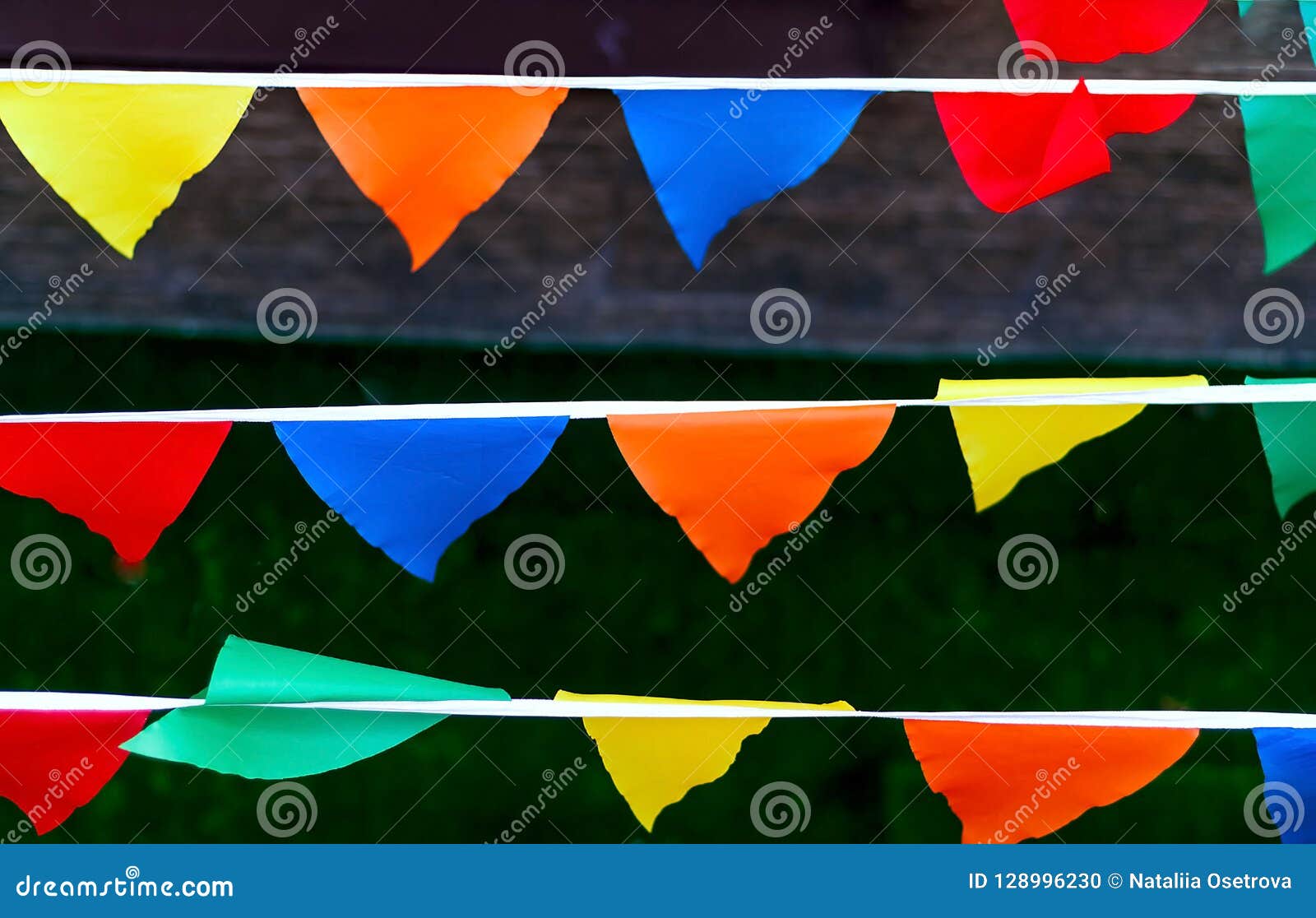 Colored Flags in the Shape of a Triangle Develop in the Wind, Close ...