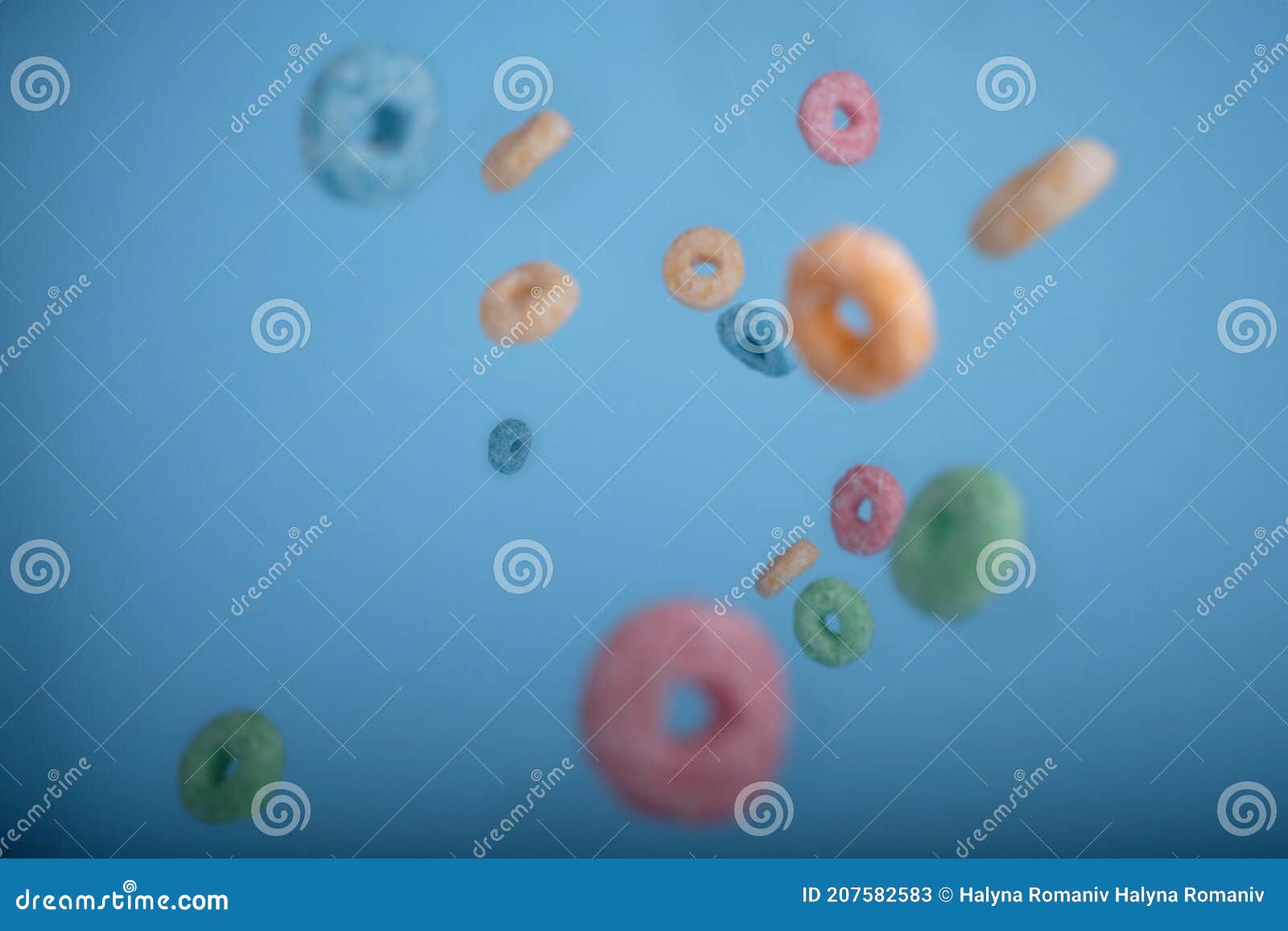 Colored Fruit Grain Loops in Levitation. on a Blue Background Stock ...