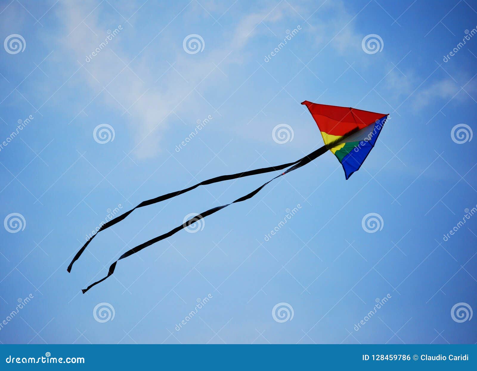 A colored kite in the sky stock photo. Image of game - 128459786