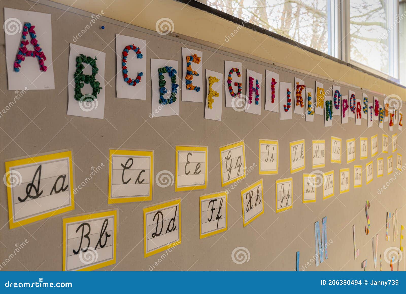 Colored Letters in Block and Cursive on the Wall of a Primary School ...