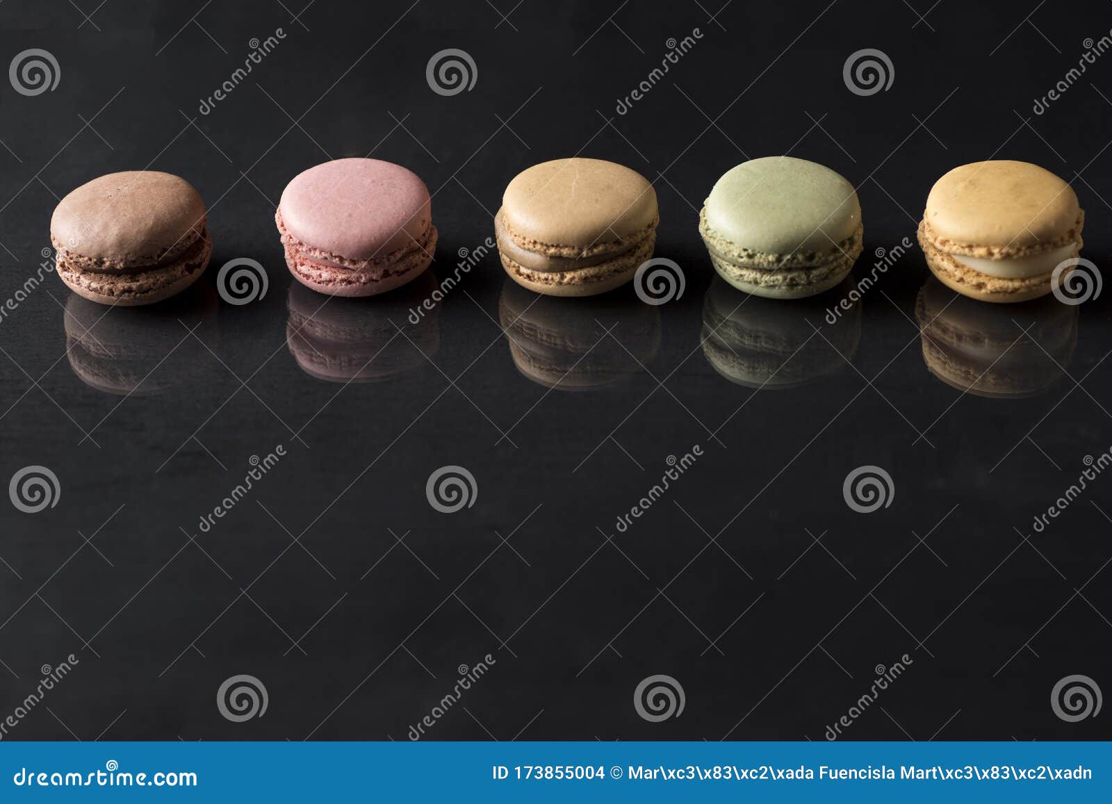 Colored Macarons on a Black Surface and with Stock Photo - Image of ...