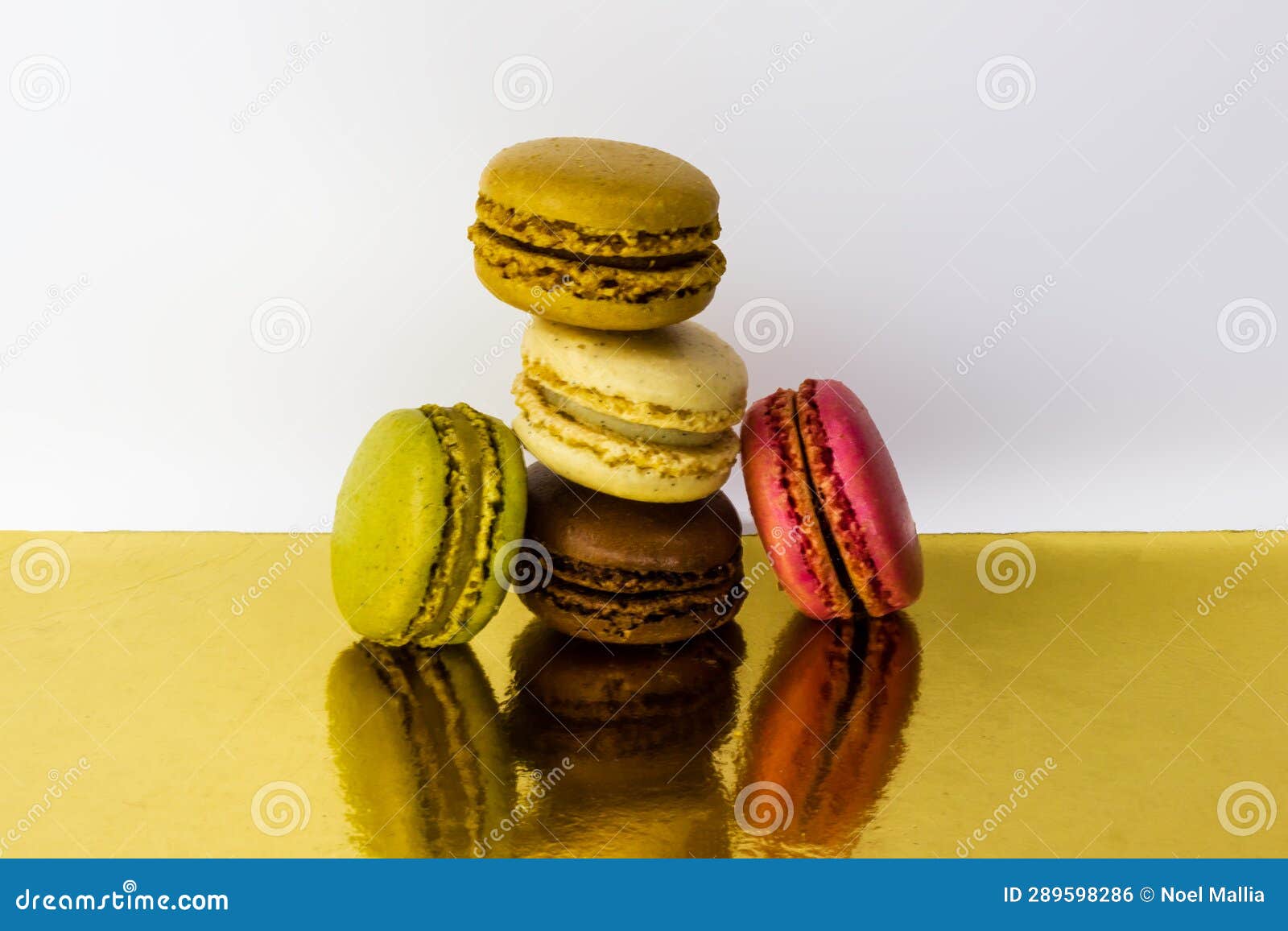 Colored Macaroon on a Golden Surface Stock Photo - Image of stack ...
