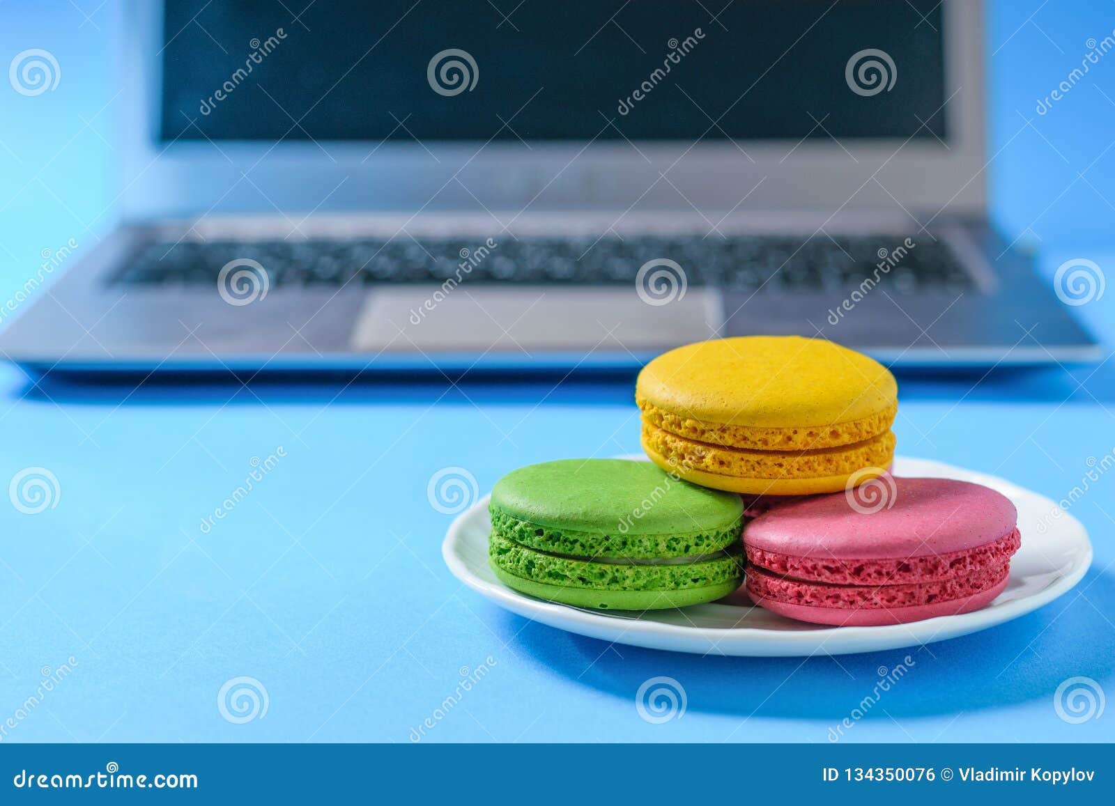 Colored Macaroons in a White Bowl on a Blue Background with the ...